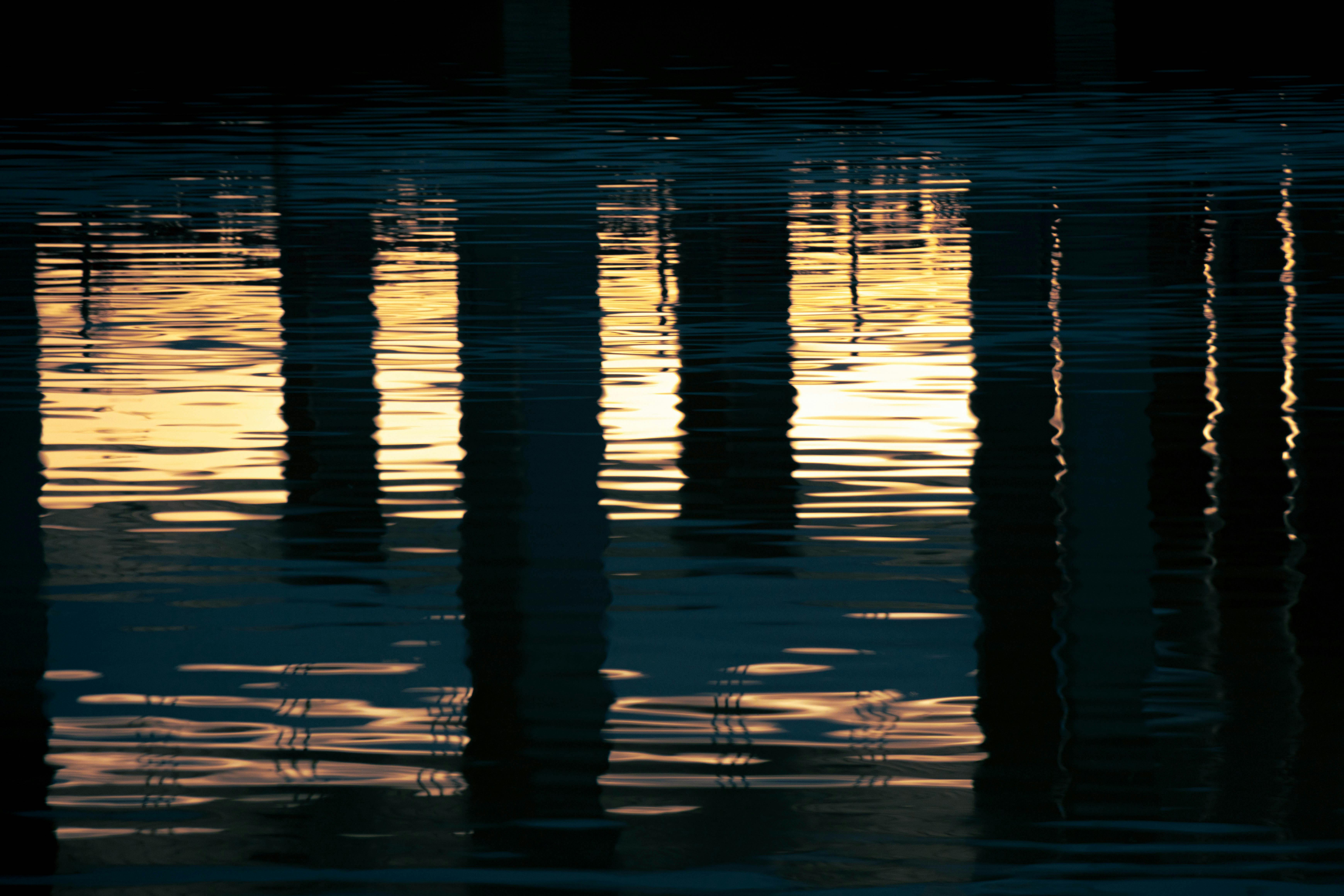 Reflection of Columns in the Water at Sunset · Free Stock Photo