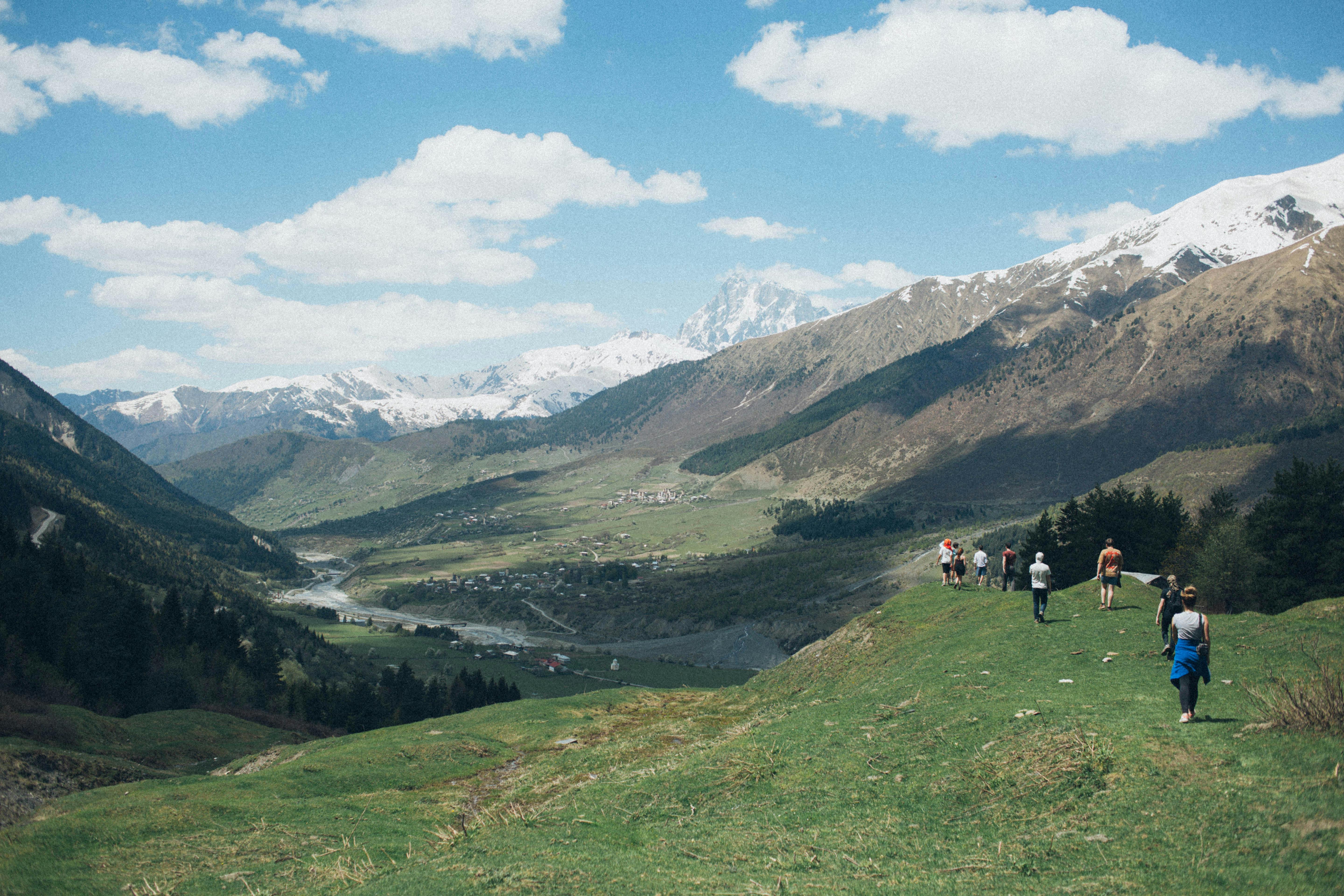 People Walking on Grass Field · Free Stock Photo