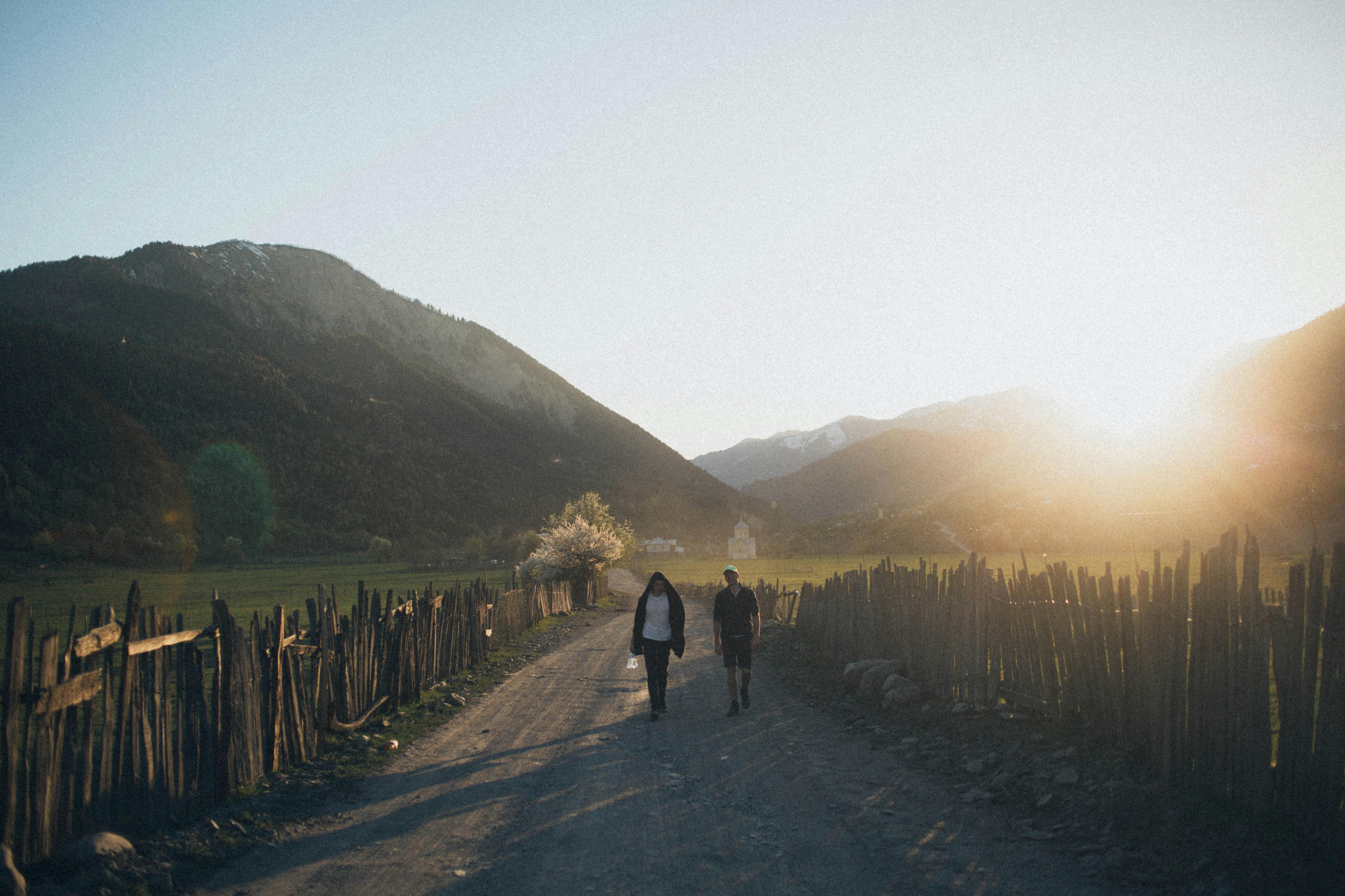 Photo of People Walking On Dirt Road · Free Stock Photo