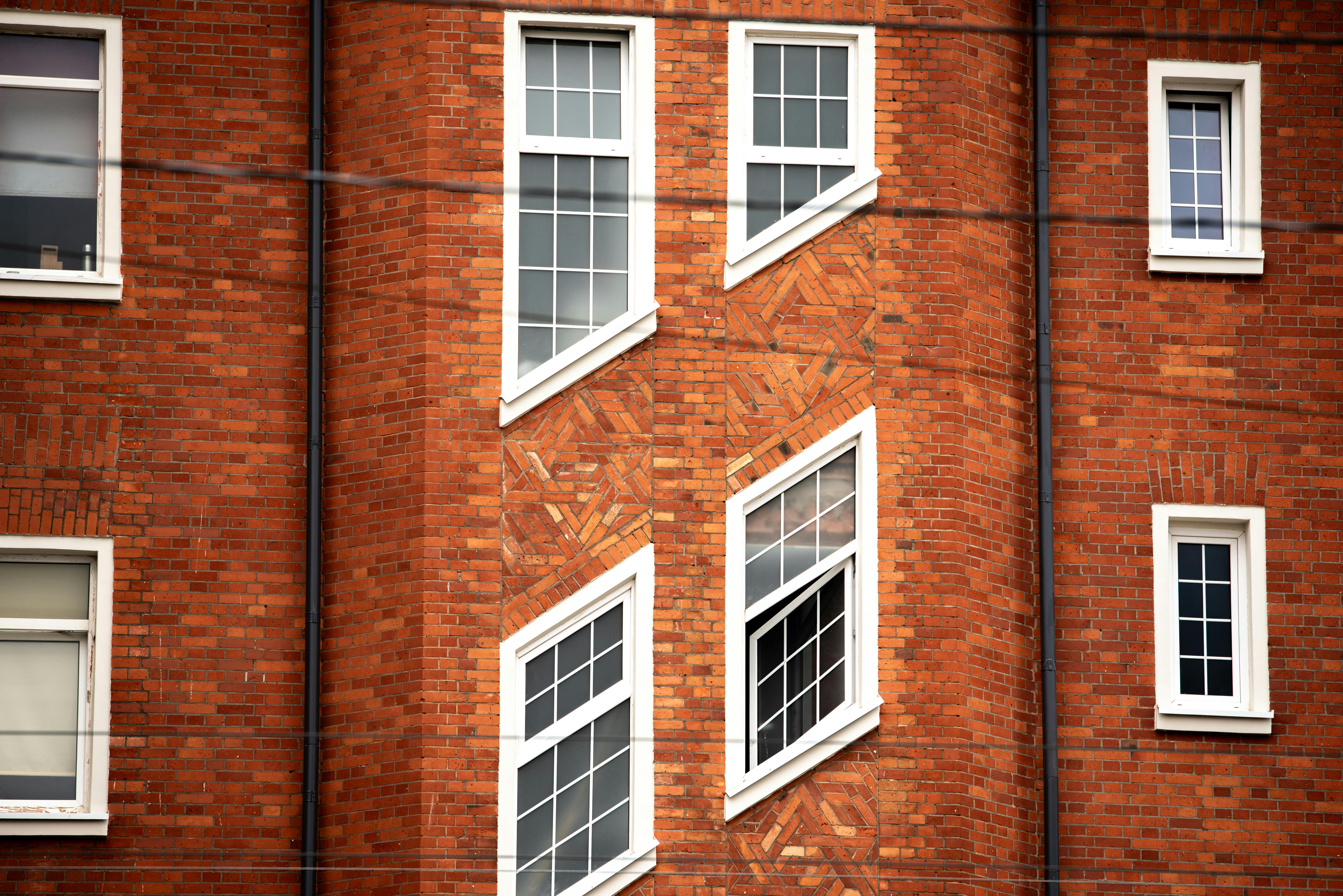 Windows of a Brick Apartment Building · Free Stock Photo