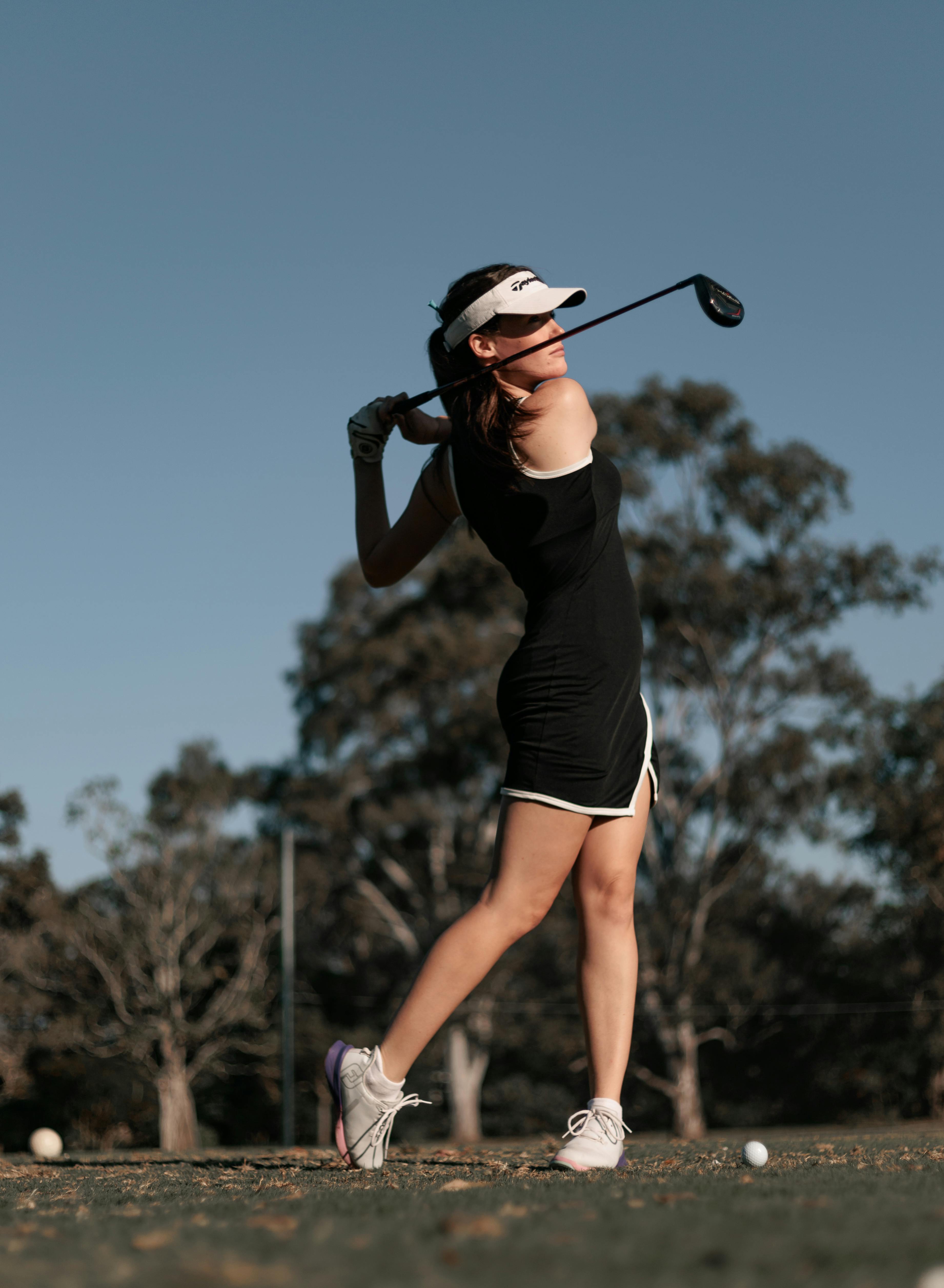 Woman Playing Golf on a Field · Free Stock Photo