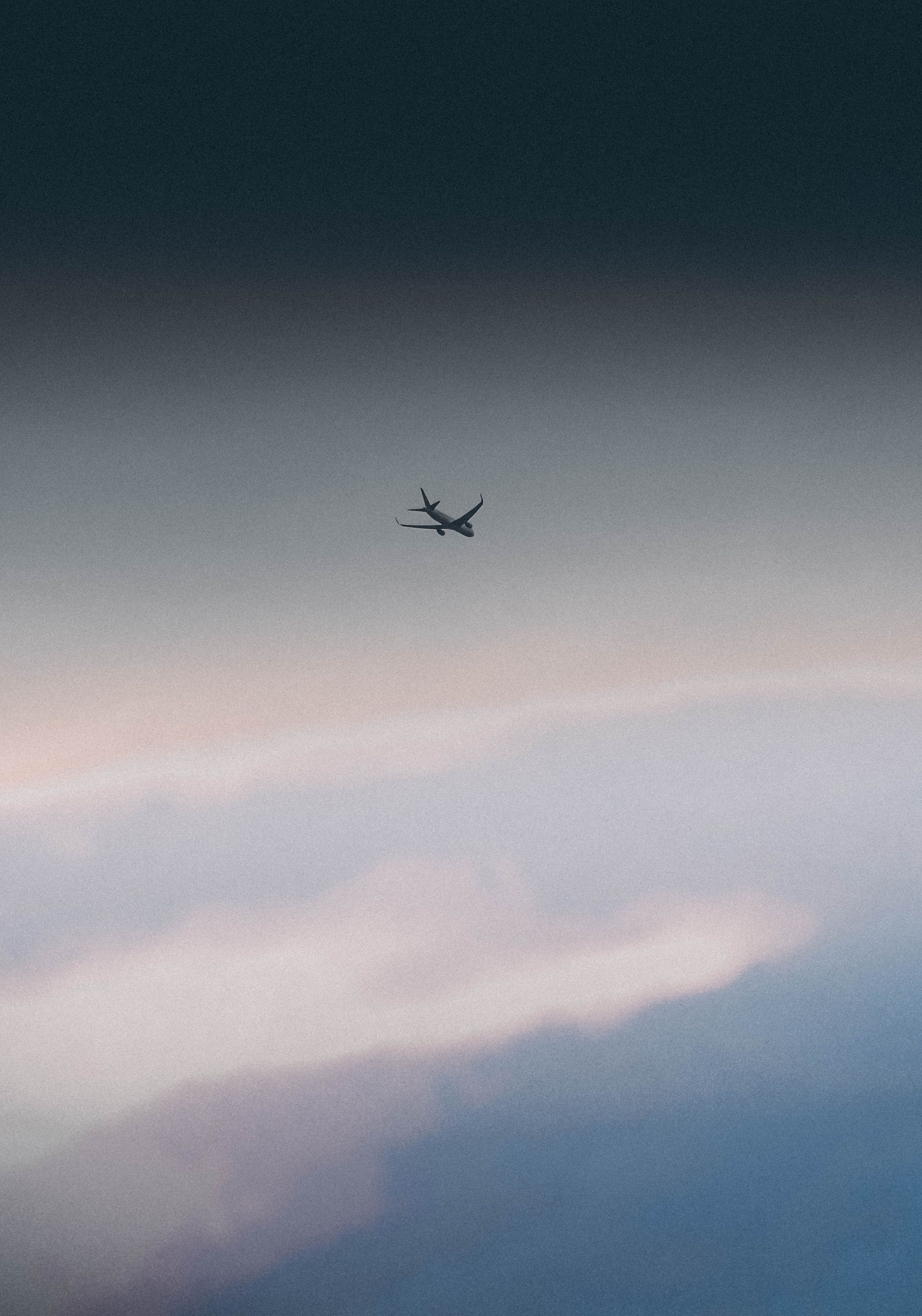 Passenger Airplane Flying at High Altitude at Dusk · Free Stock Photo