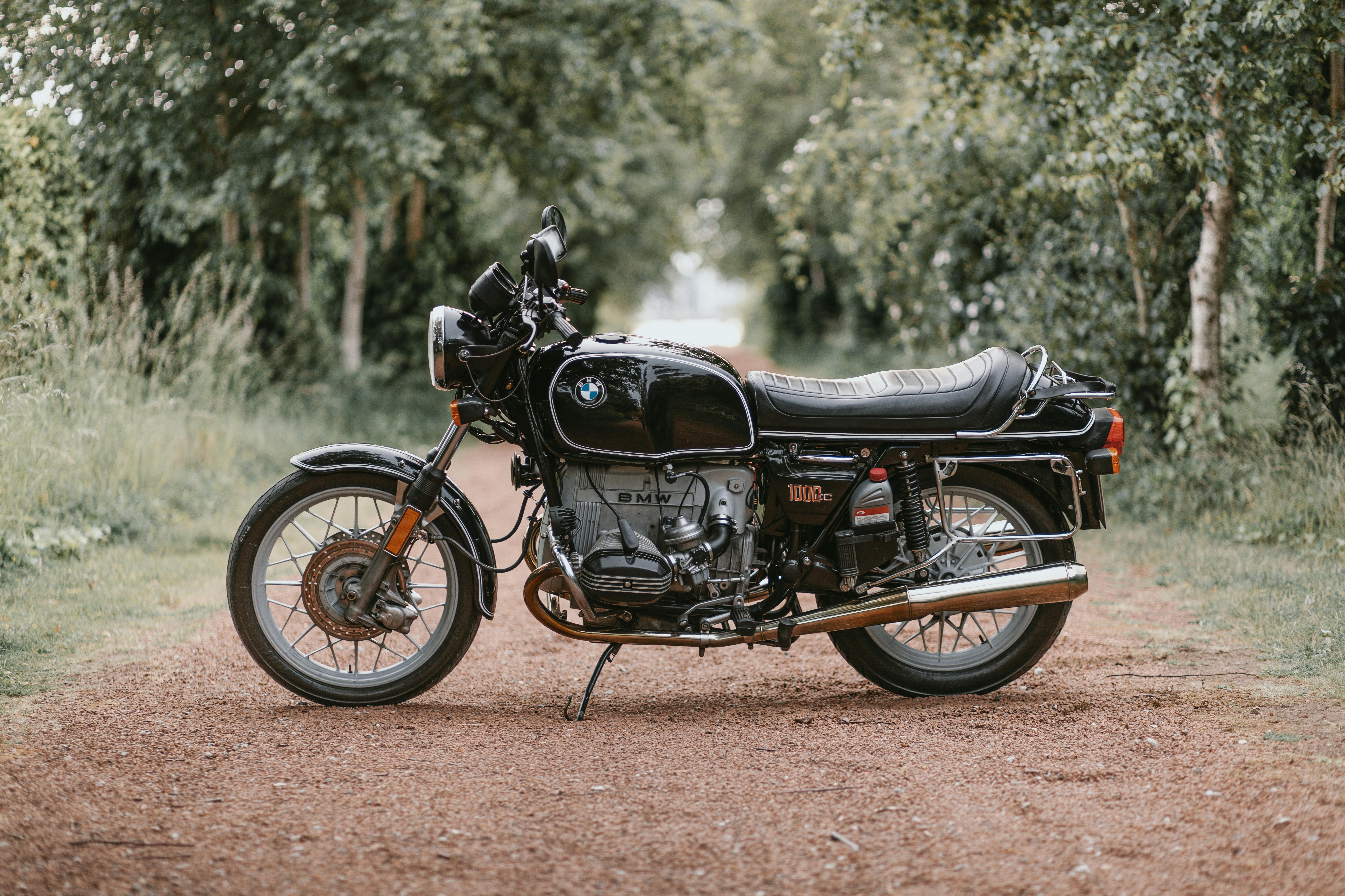 Black Vintage BMW Motorcycle Parked on a Dirt Road · Free Stock Photo