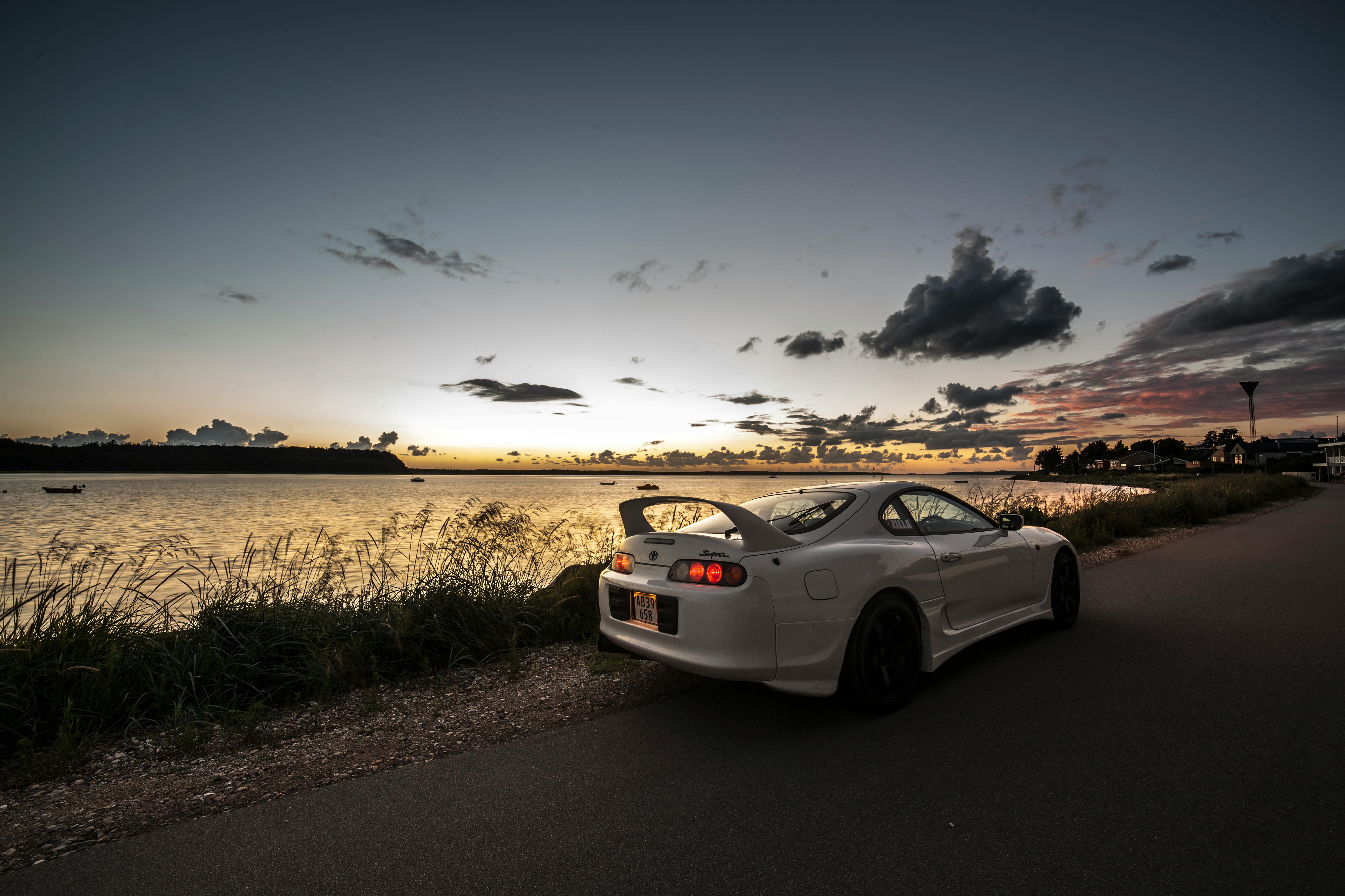 White Toyota Supra on Sea Shore at Sunset · Free Stock Photo