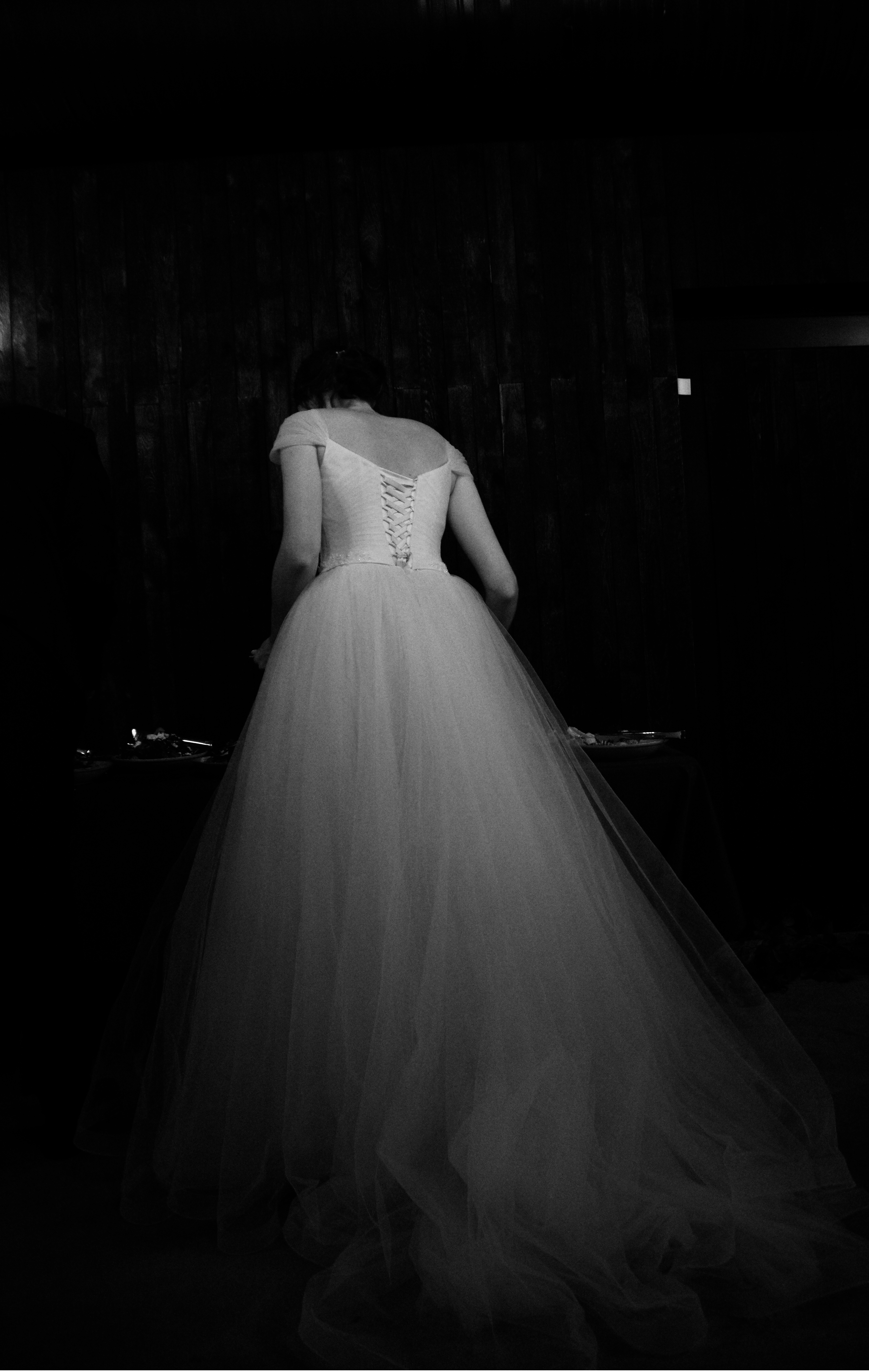 Back View of Bride in Wedding Dress in Darkness · Free Stock Photo