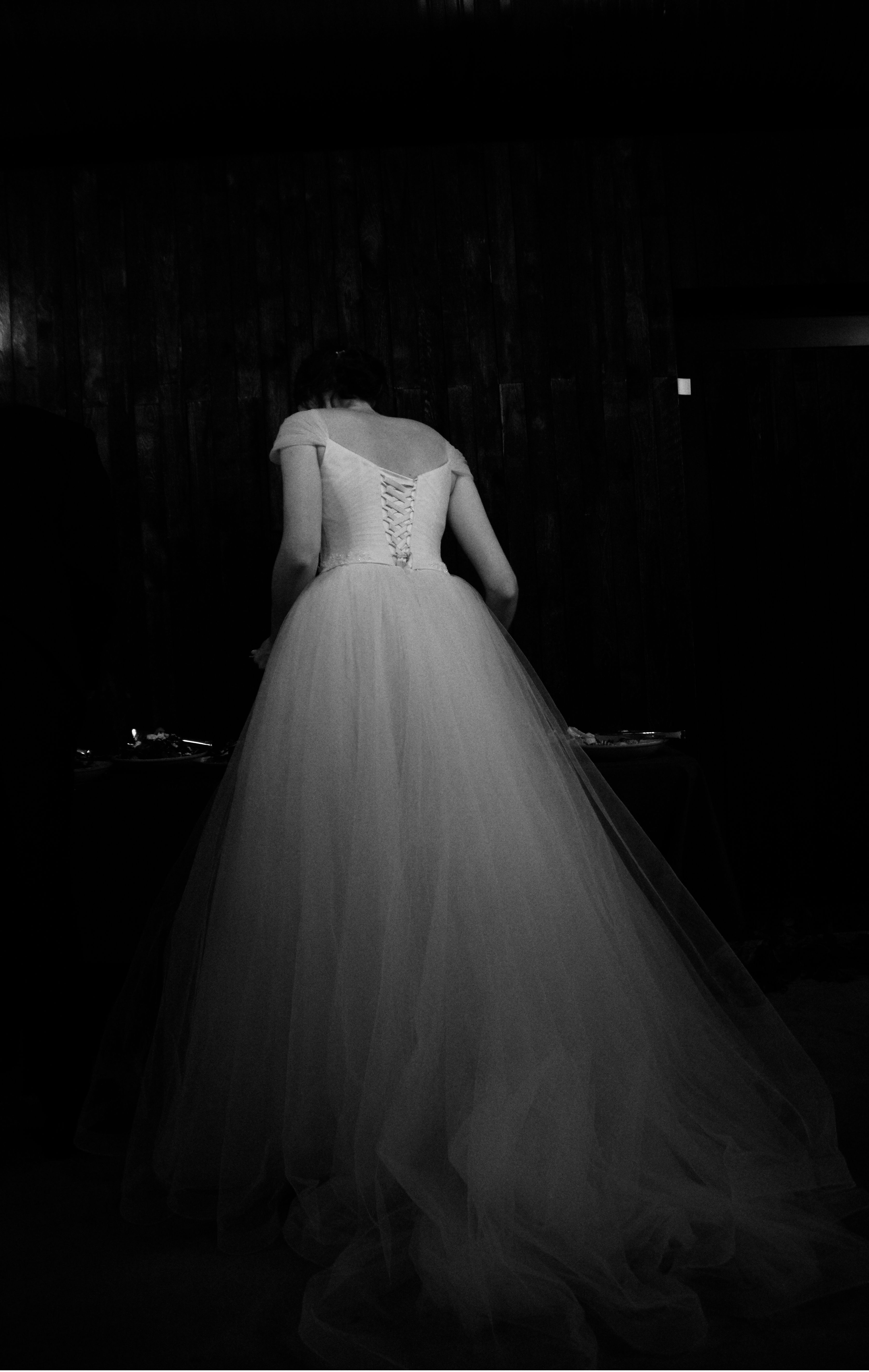 Back View of Bride in Wedding Dress in Darkness · Free Stock Photo