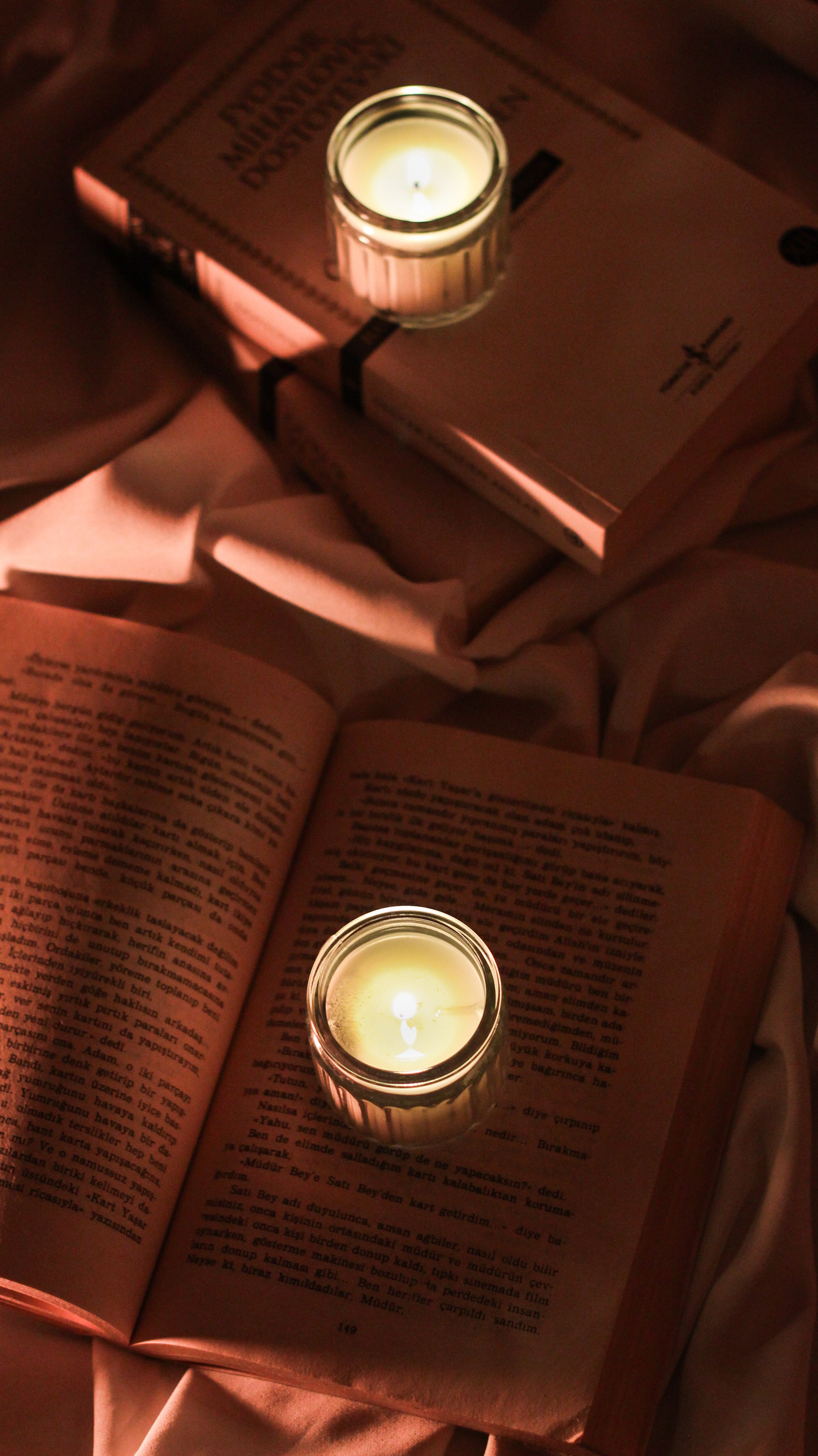 Candles Opened Book on White Textile · Free Stock Photo