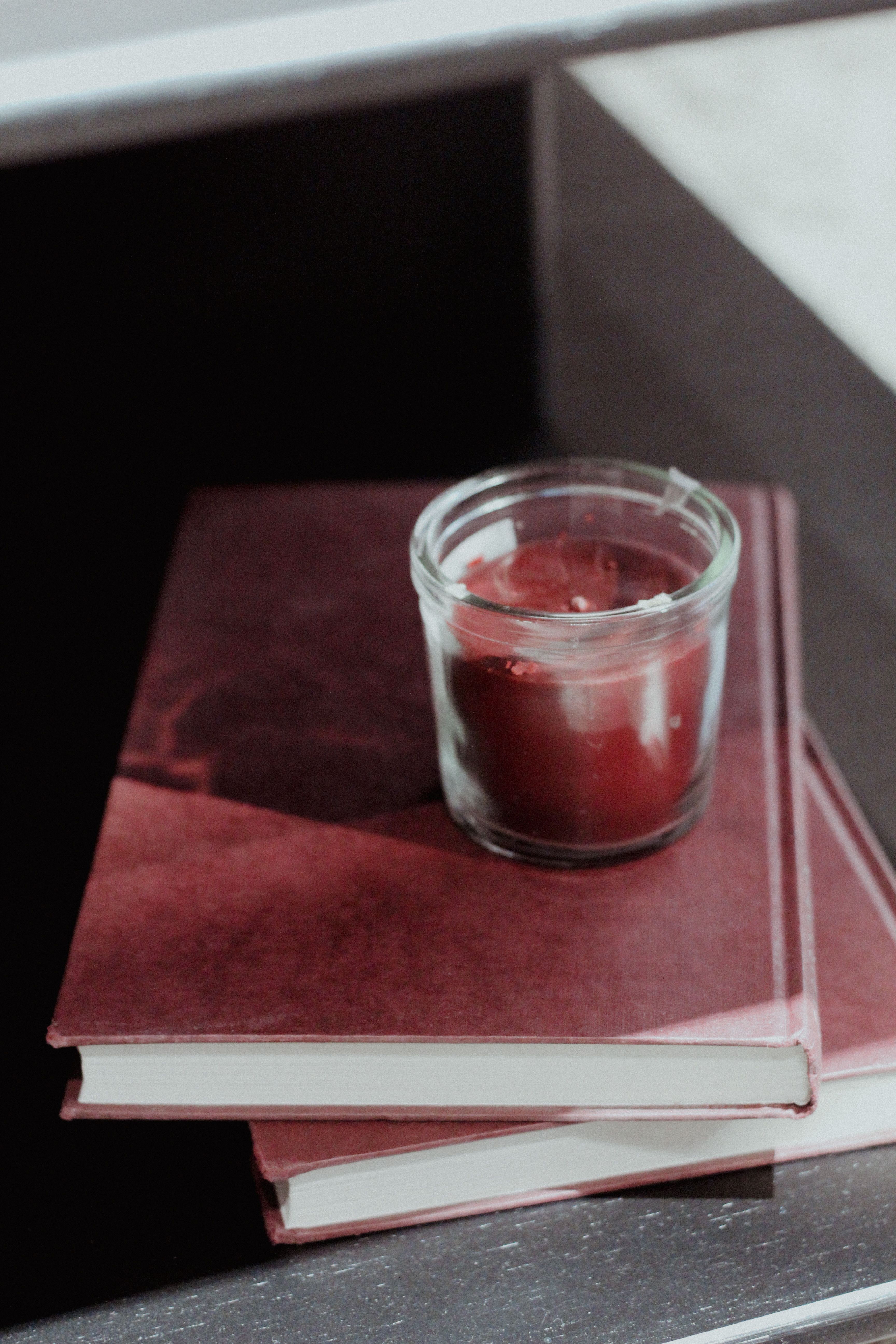 Red Wax Candle on Red Books Covers · Free Stock Photo