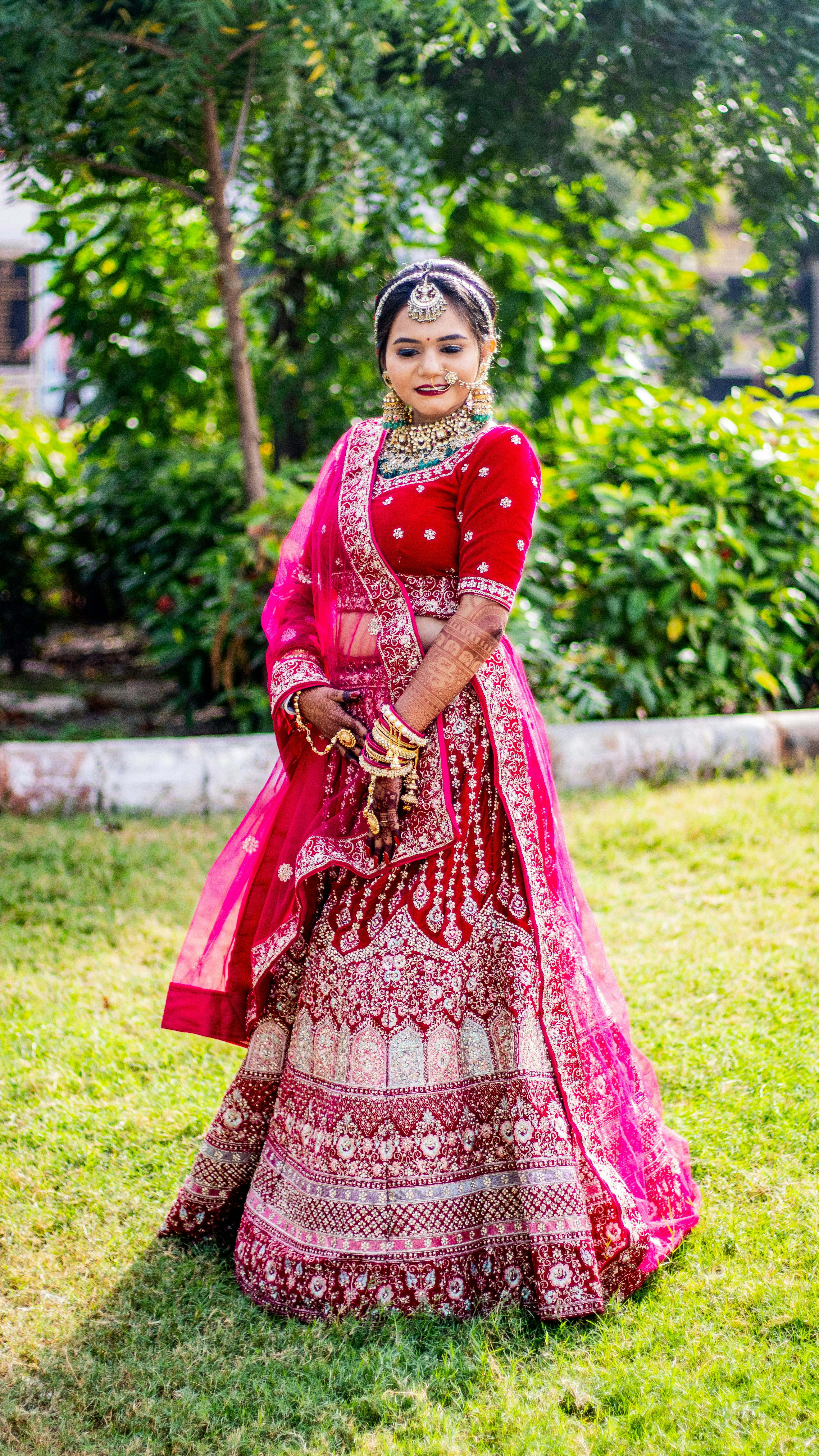 Laughing Bride in a Red Saree Among Falling Golden Petals · Free Stock ...