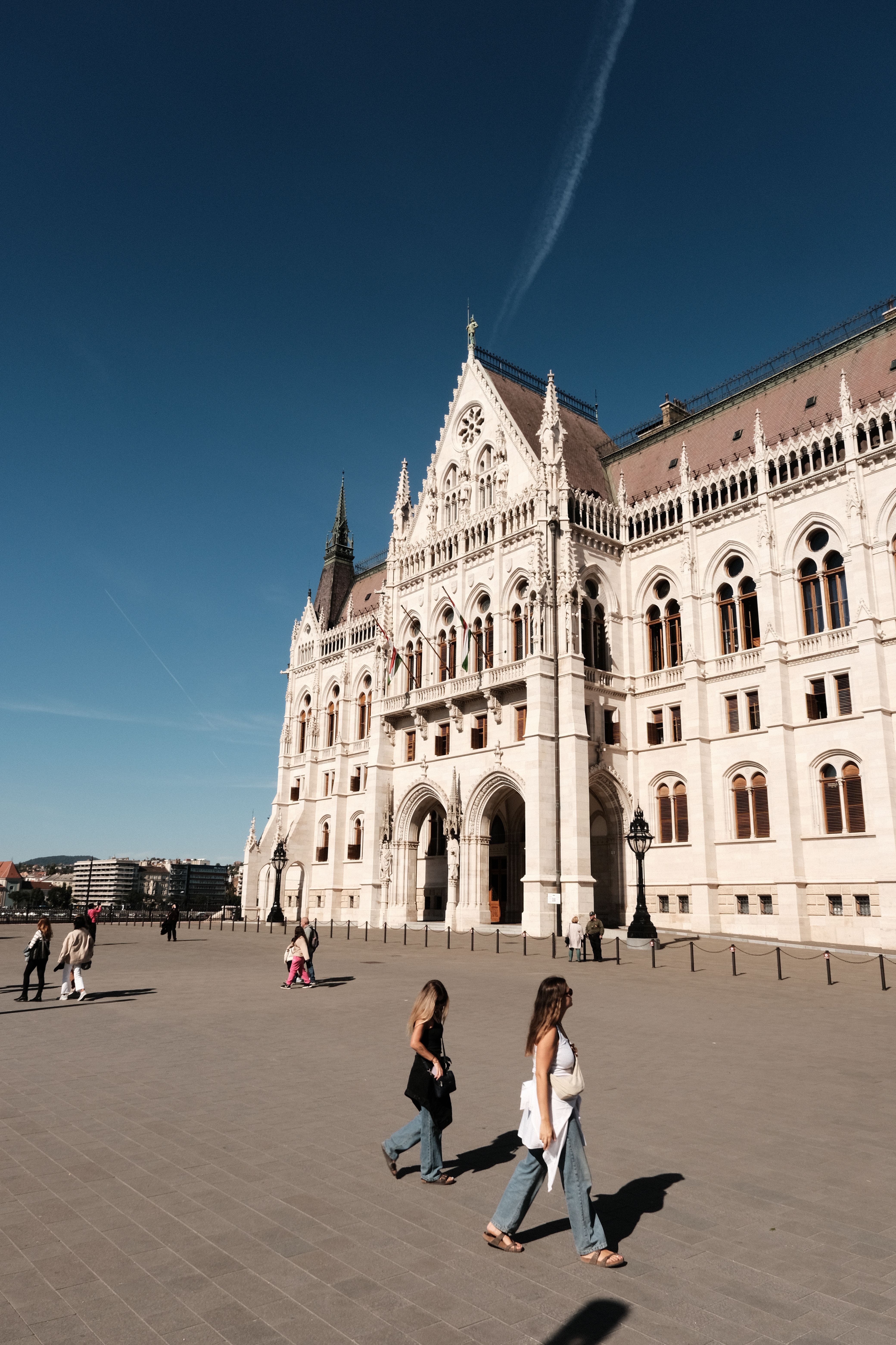 People walking in front of a large building · Free Stock Photo