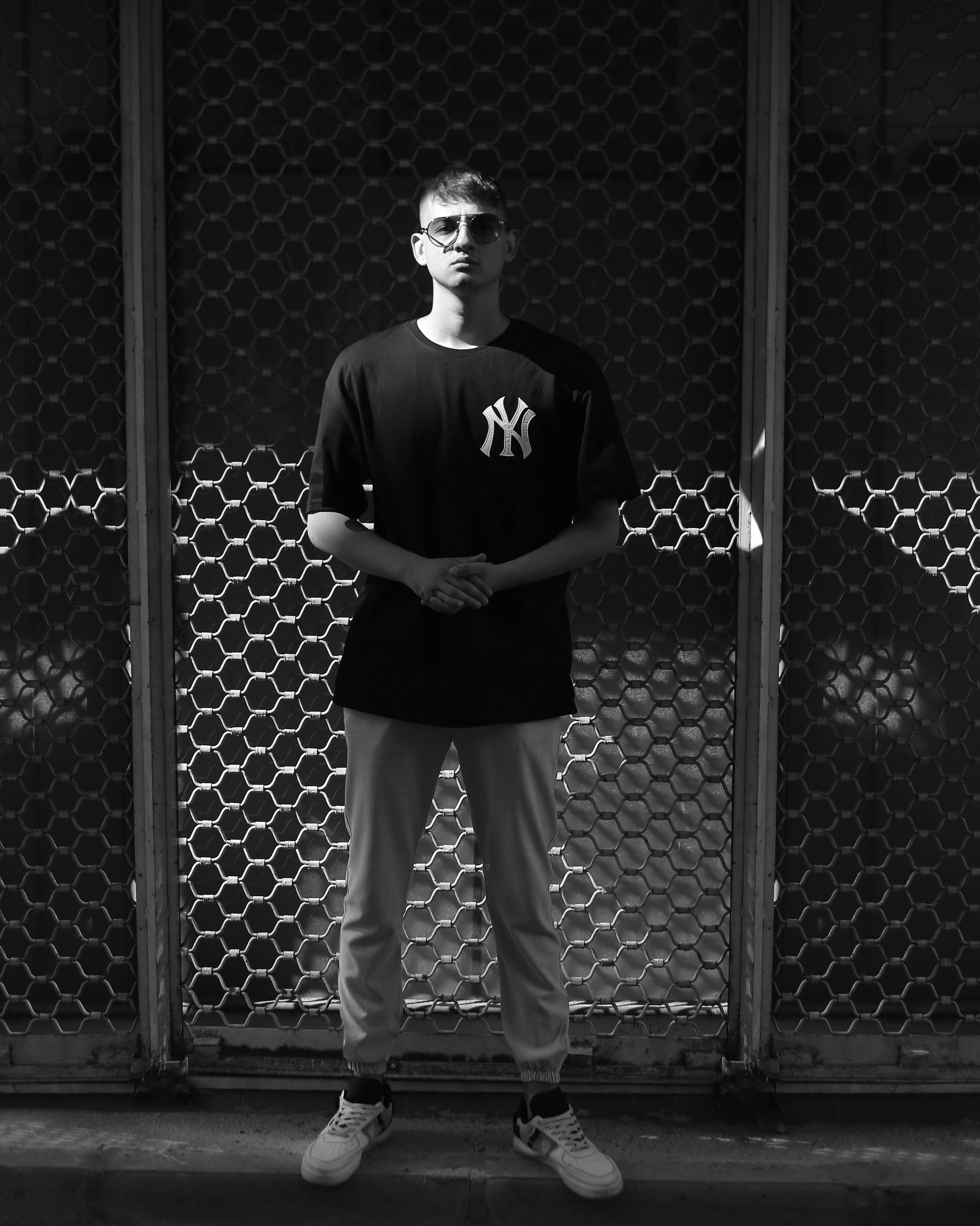 Man Standing by Fence · Free Stock Photo