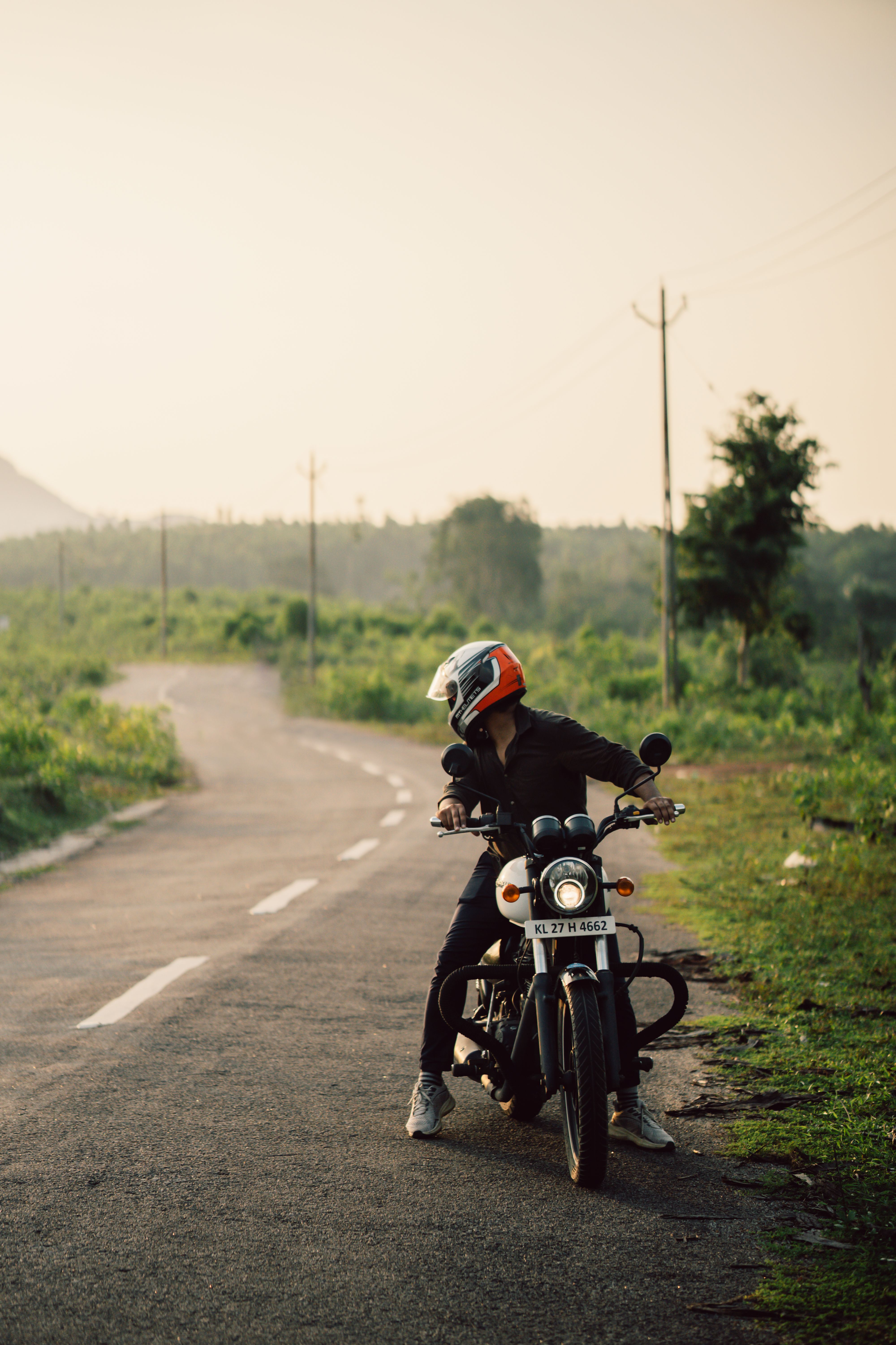 Biker Looking Back at the Country Road Behind · Free Stock Photo