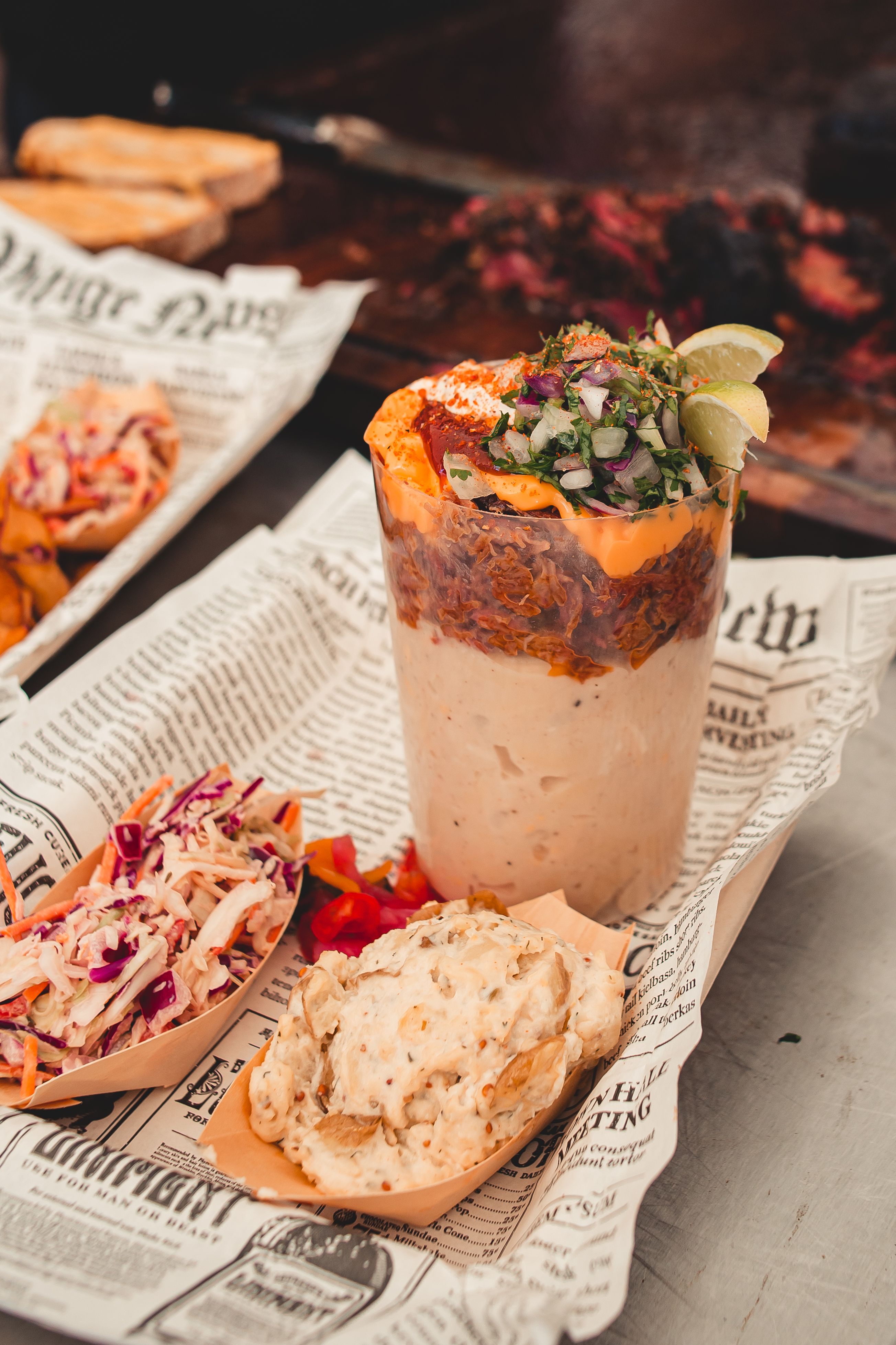 Food in a BBQ Bar Presented on a Newspaper Page · Free Stock Photo