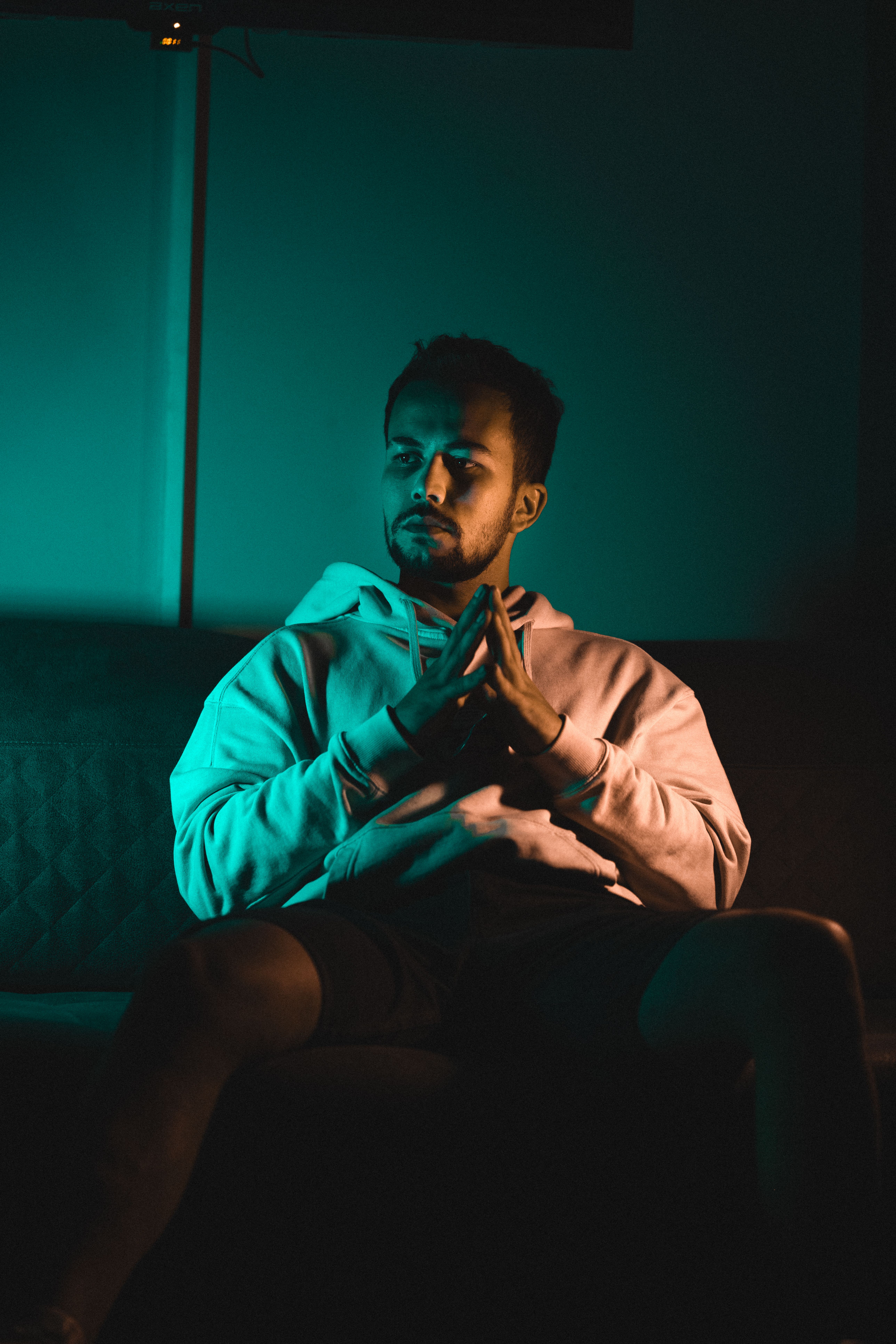 Green Light over Man Sitting on Couch · Free Stock Photo
