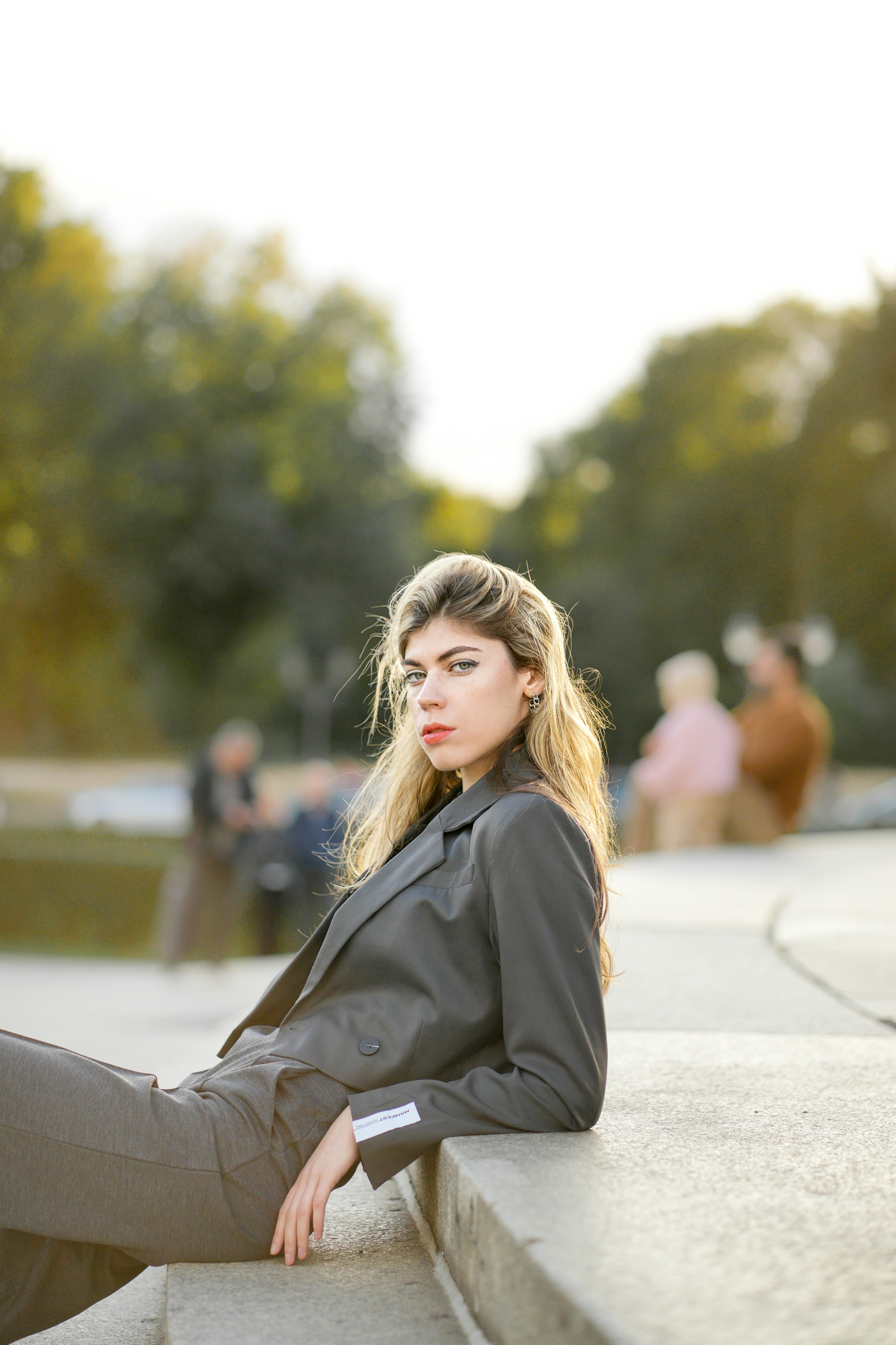 Blonde Woman Sitting on a Square · Free Stock Photo