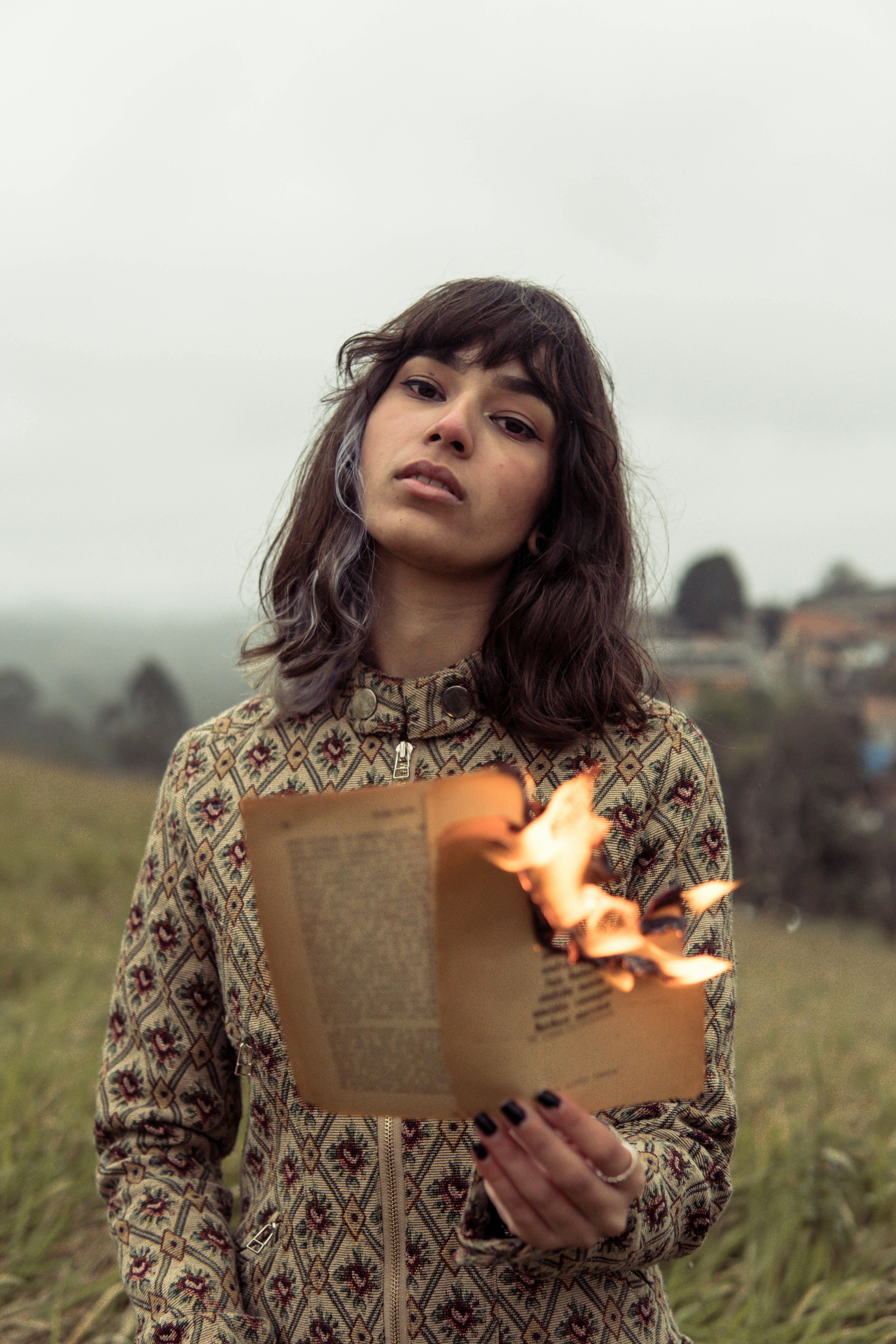 Woman Burning Book Pages in Hand · Free Stock Photo