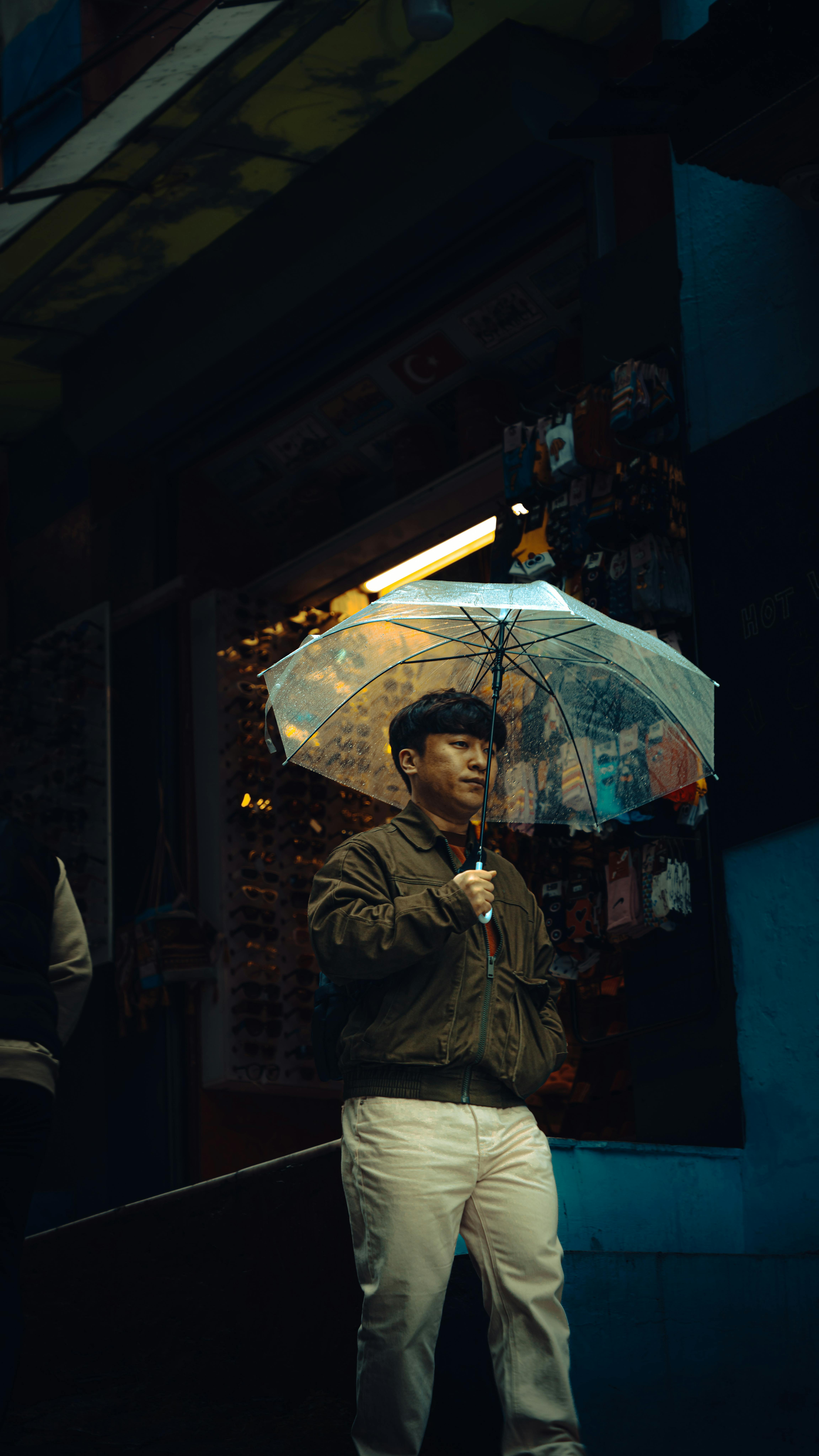 Man Walking Down Street Holding Camera · Free Stock Photo