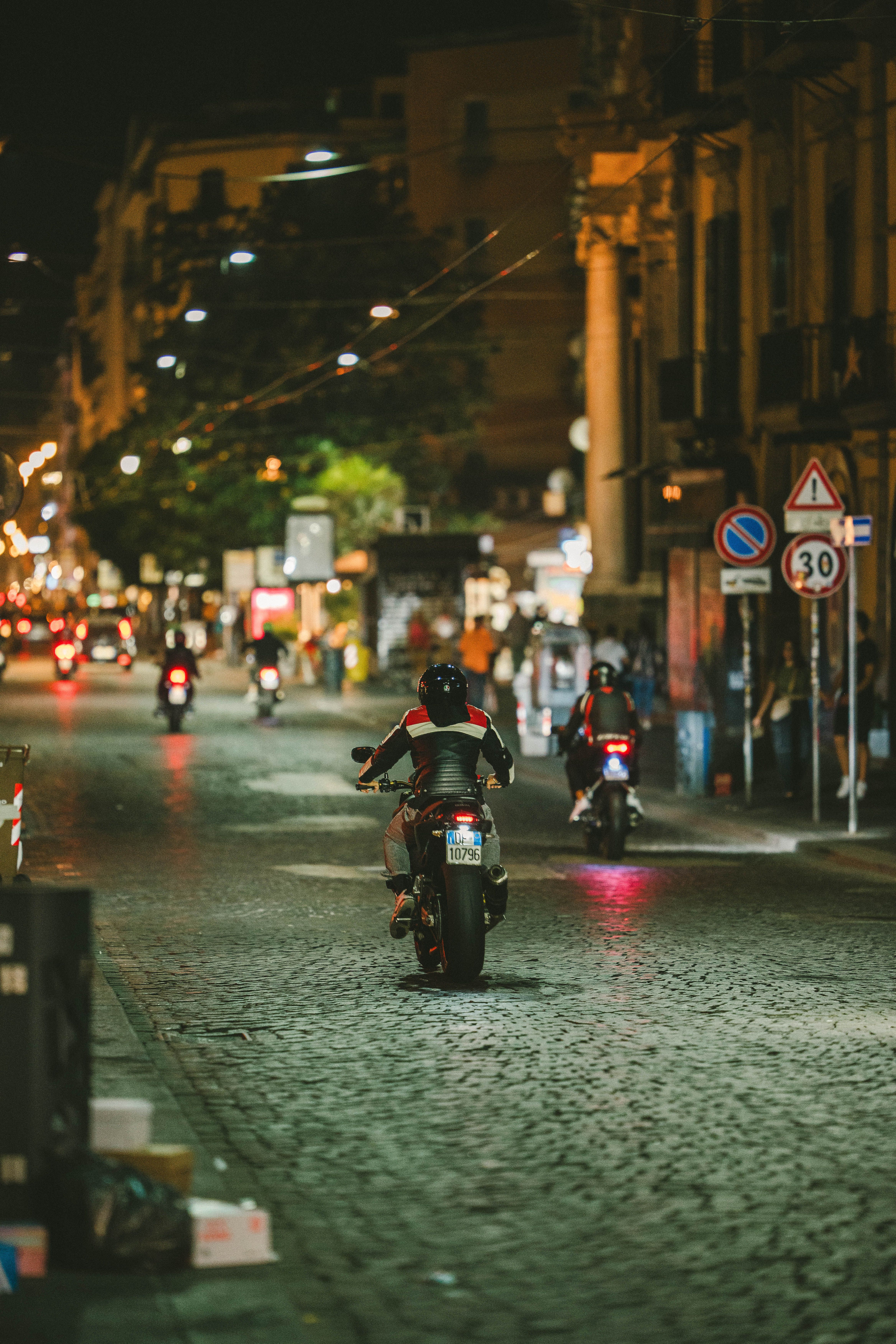 Motorcyclists Riding on a Street in City at Night · Free Stock Photo