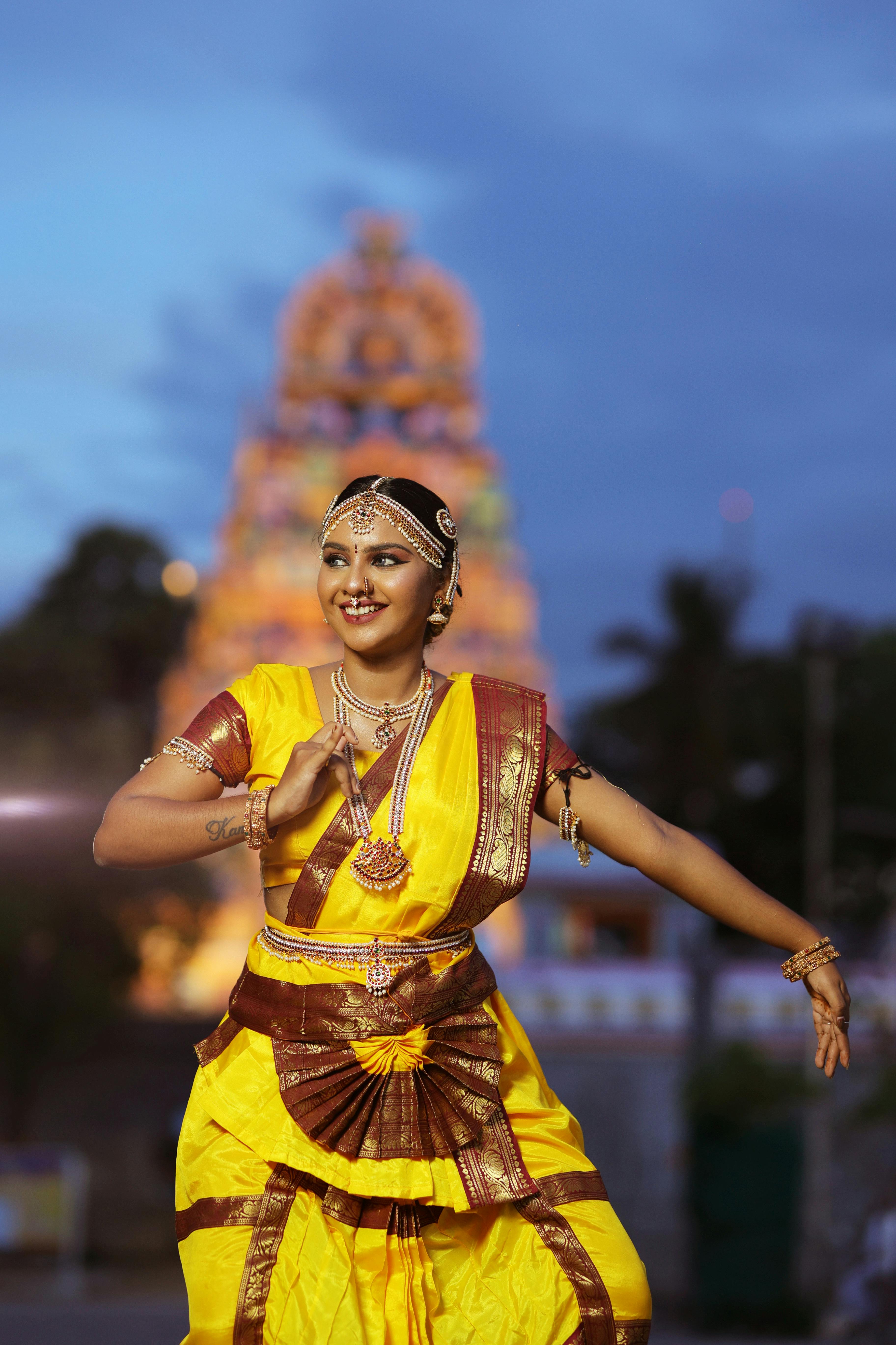 A Woman in Gold Saree Dancing a Traditional Dance · Free Stock Photo