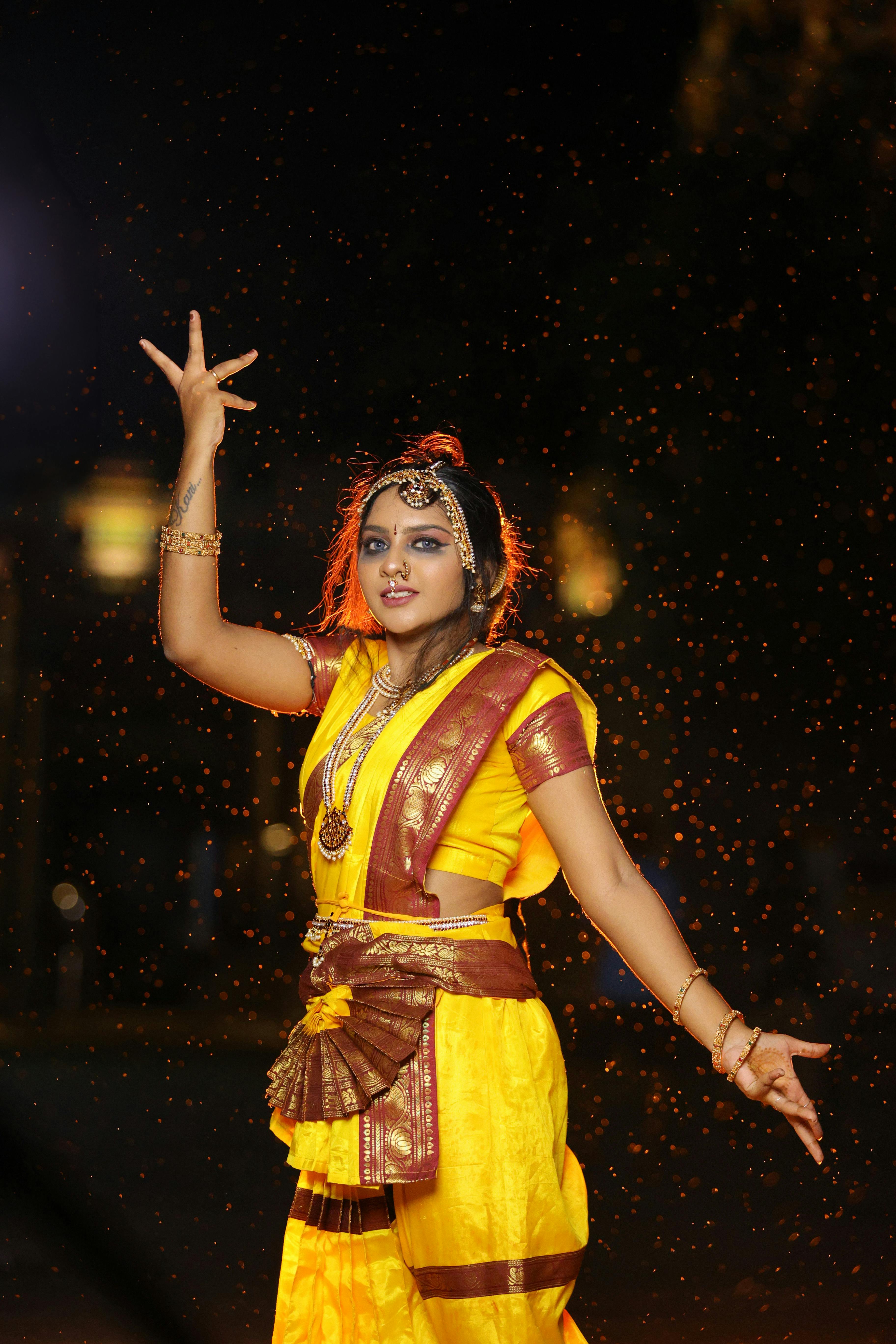 A Woman in Gold Saree Dancing a Traditional Dance · Free Stock Photo