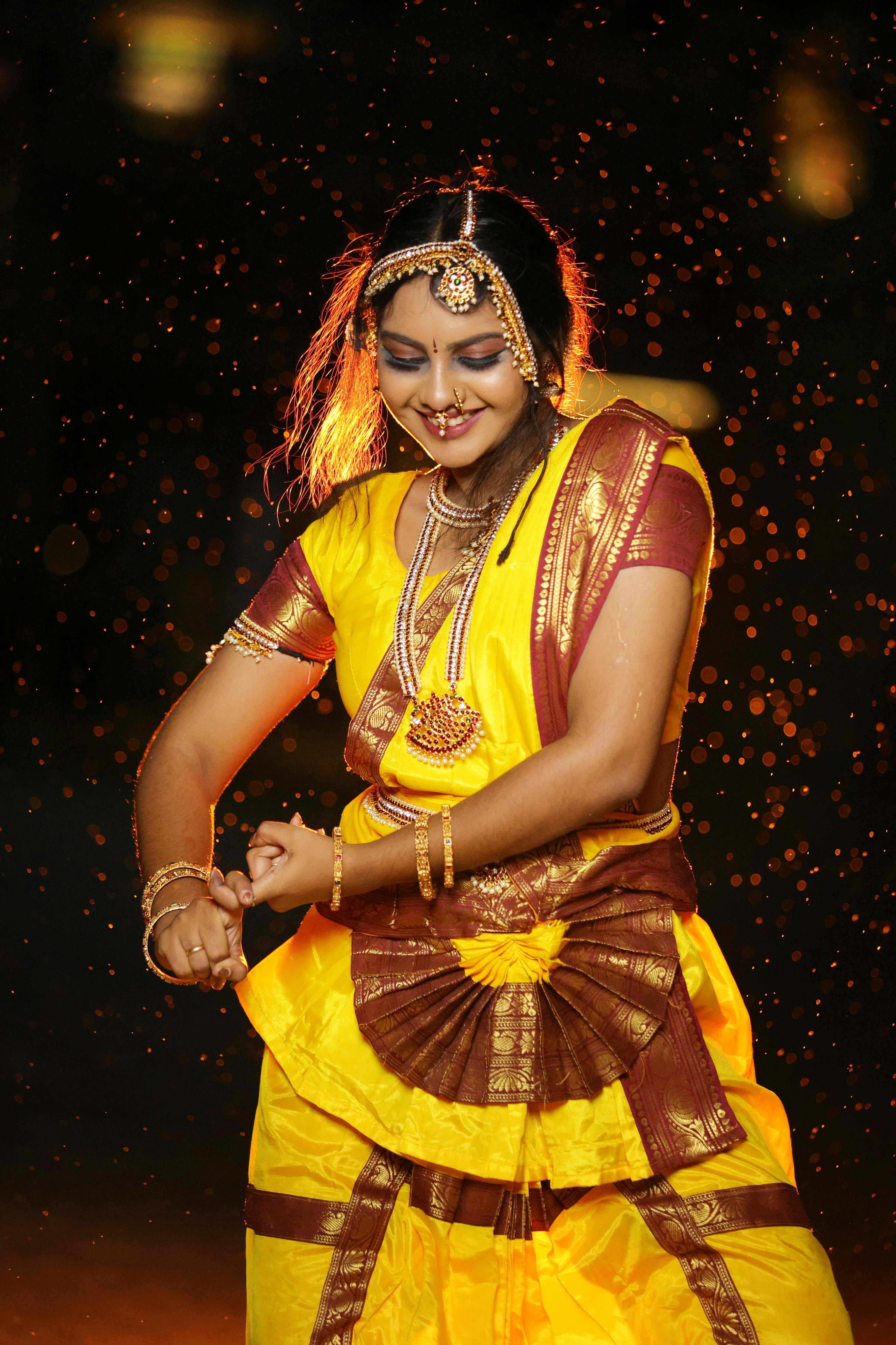 A Woman in Gold Saree Dancing a Traditional Dance · Free Stock Photo