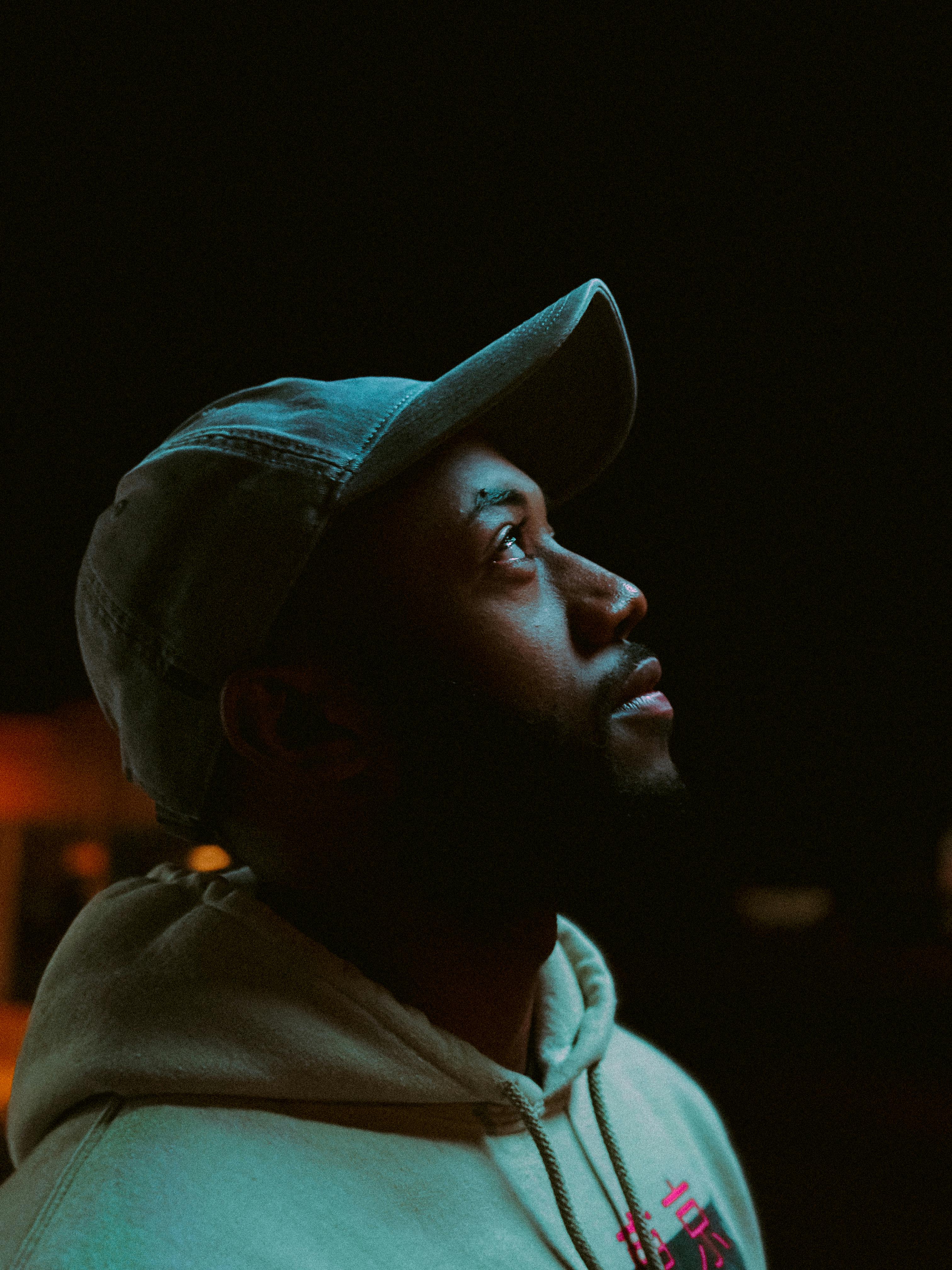 Side View of a Man Wearing a Hoodie and a Cap · Free Stock Photo