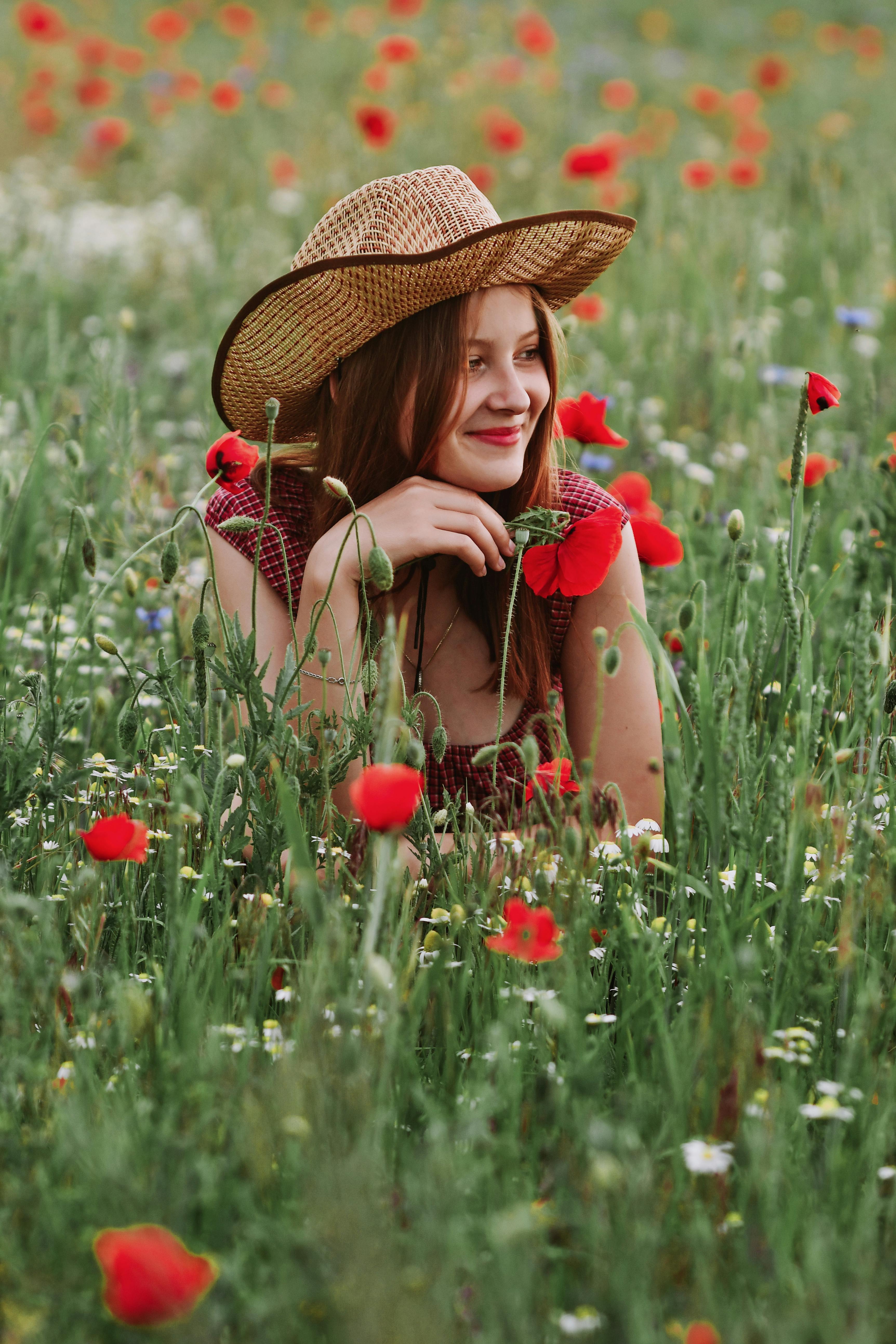 Smiling Woman in Hat among Blooming Poppies · Free Stock Photo