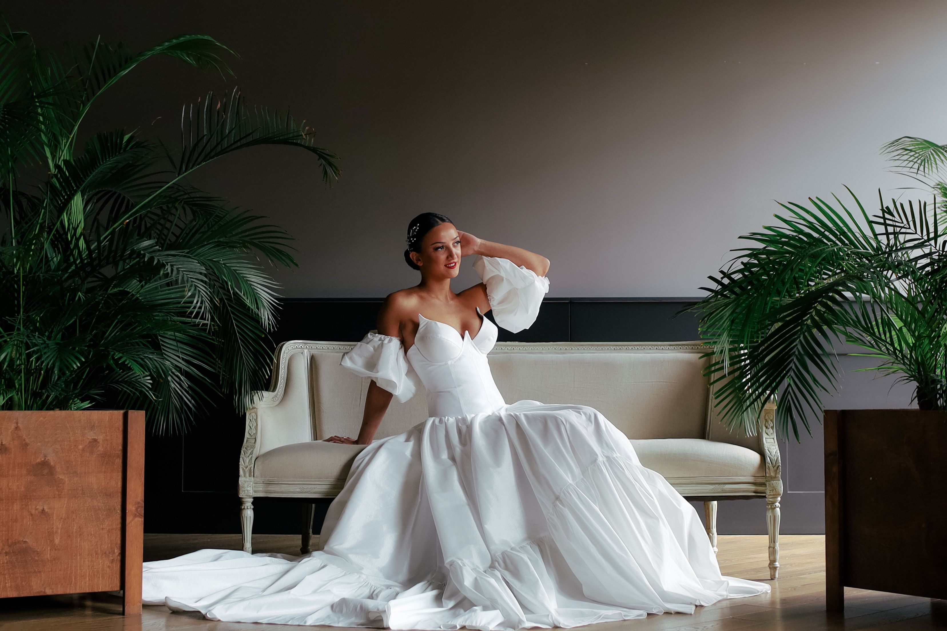 Sitting on Sofa Bride in Wedding Dress Fixing Hair · Free Stock Photo