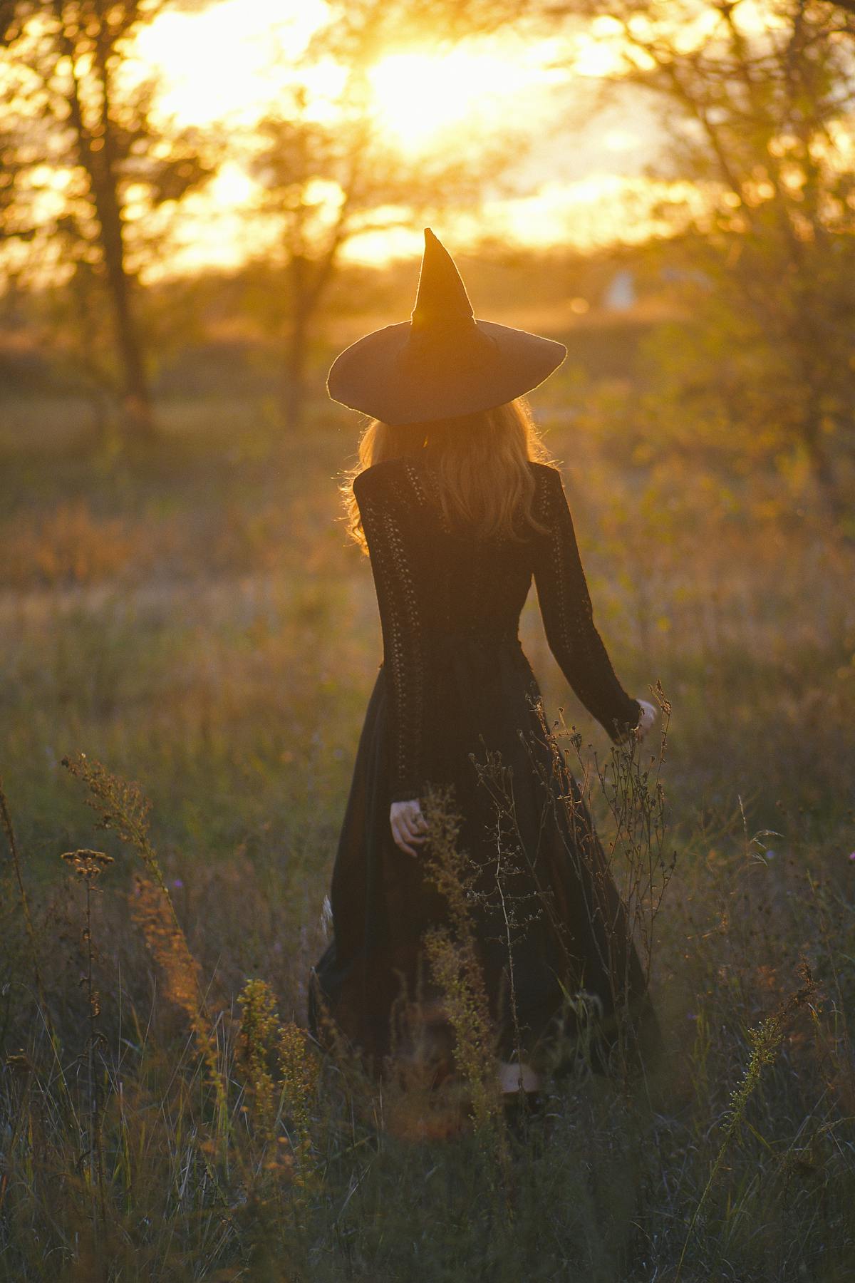 Witch Costume Walking On A Field Photos, Download The BEST Free Witch ...