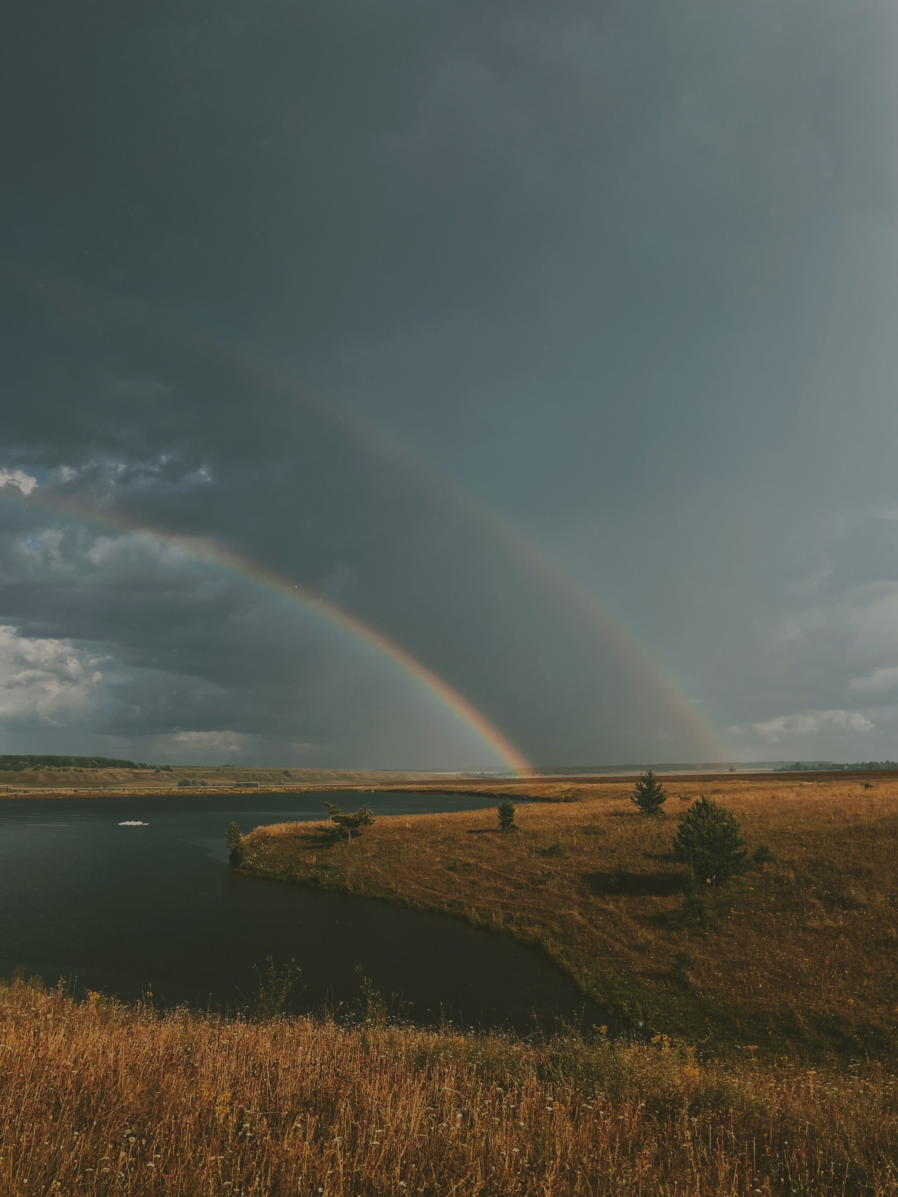 Double Rainbow above River Running through Field · Free Stock Photo