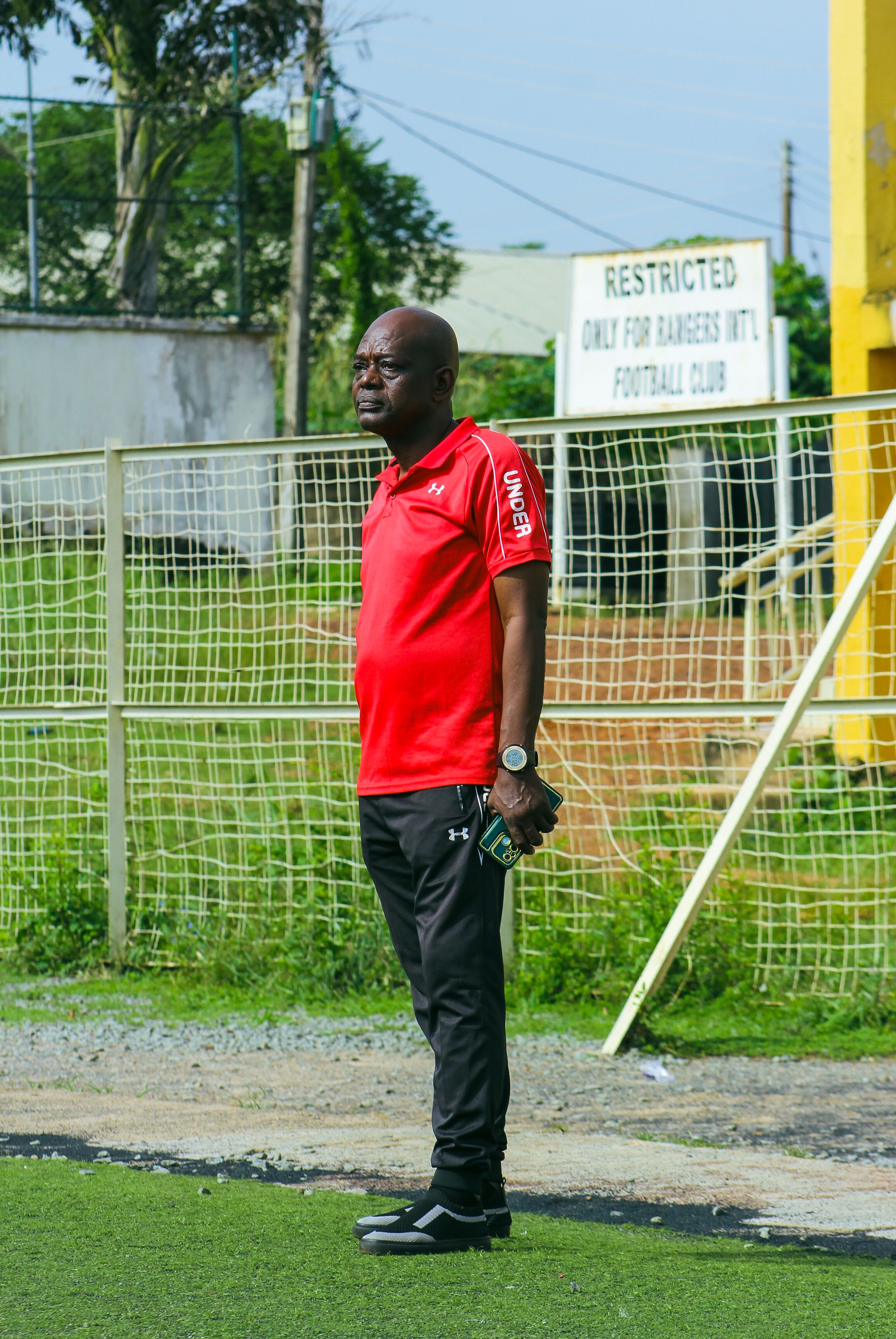 Man in Red Polo Shirt and Black Pants Standing on Soccer Field · Free ...