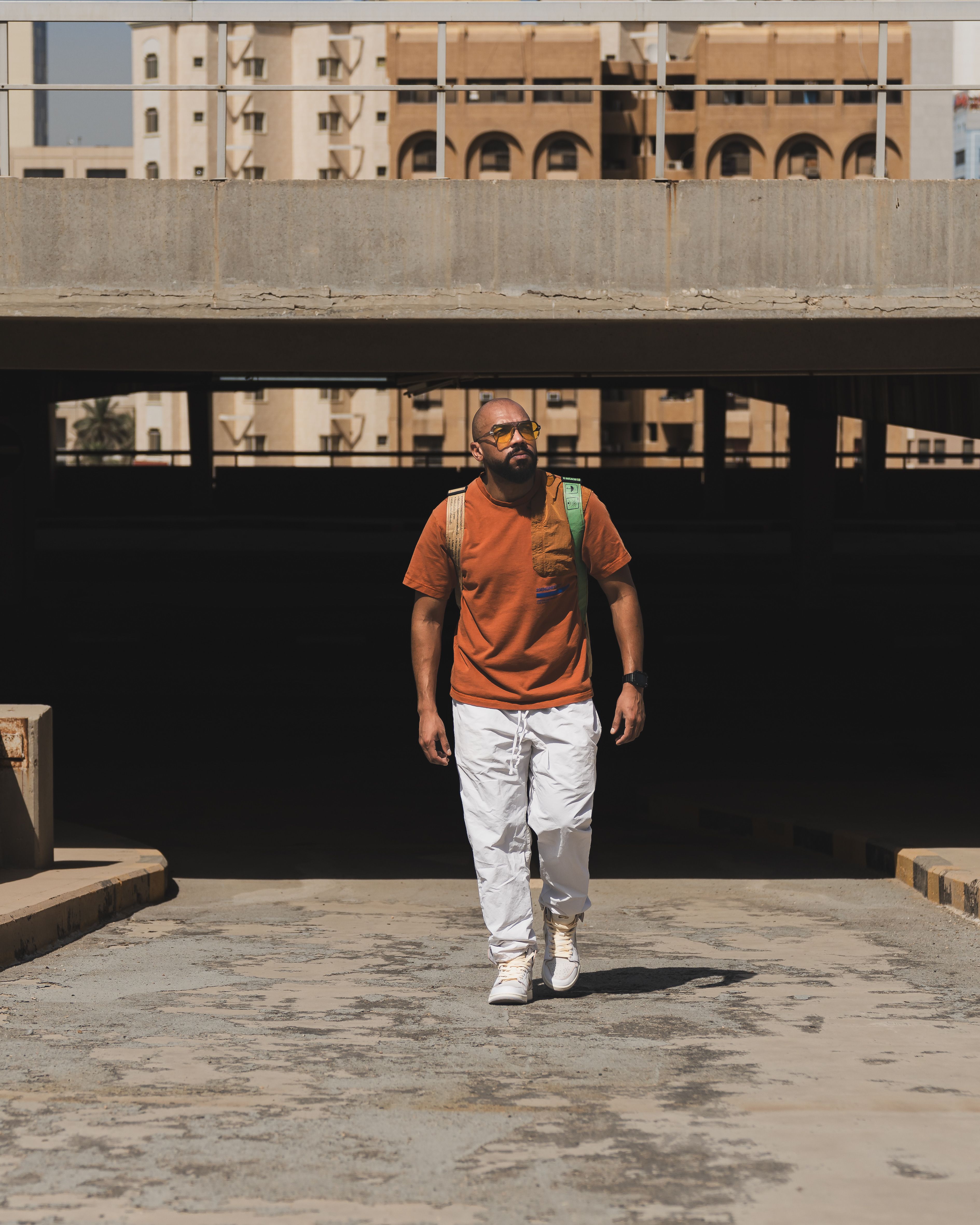 Man Walking near Building Wall · Free Stock Photo