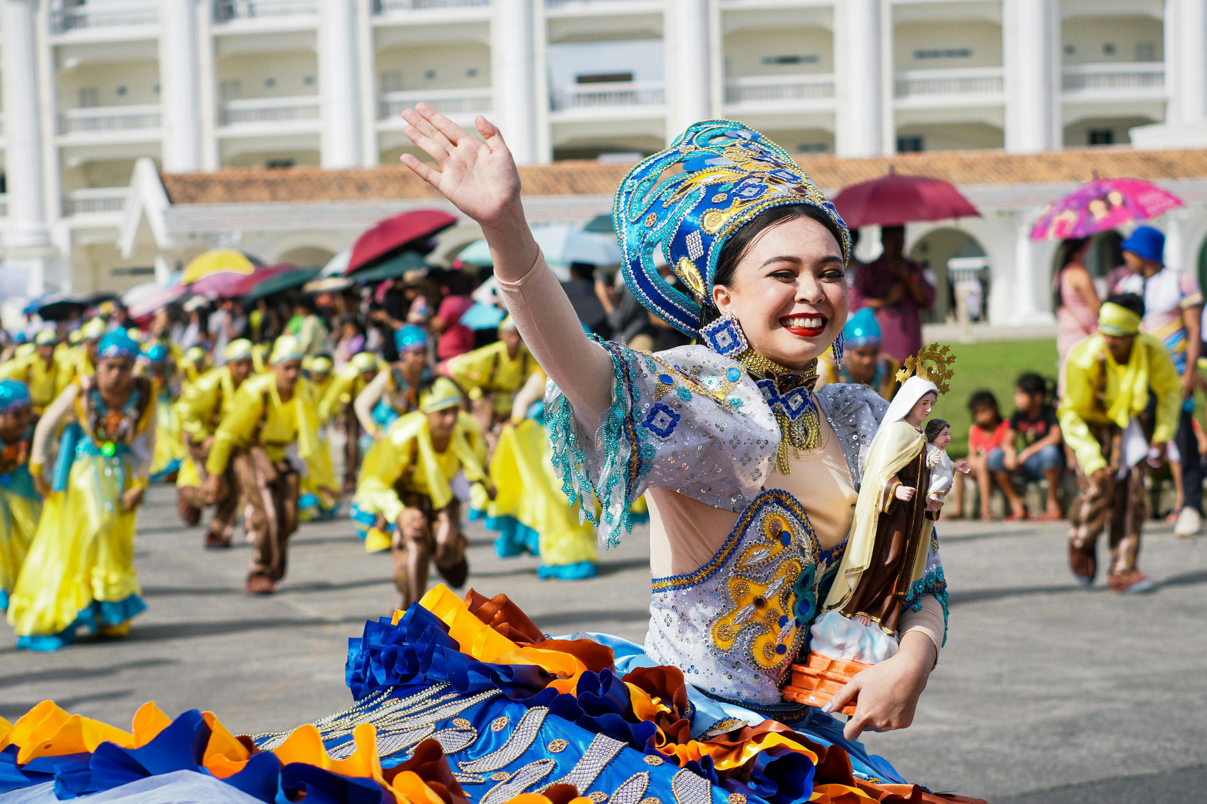 Female Dancer Waving and Smiling During a Parade · Free Stock Photo