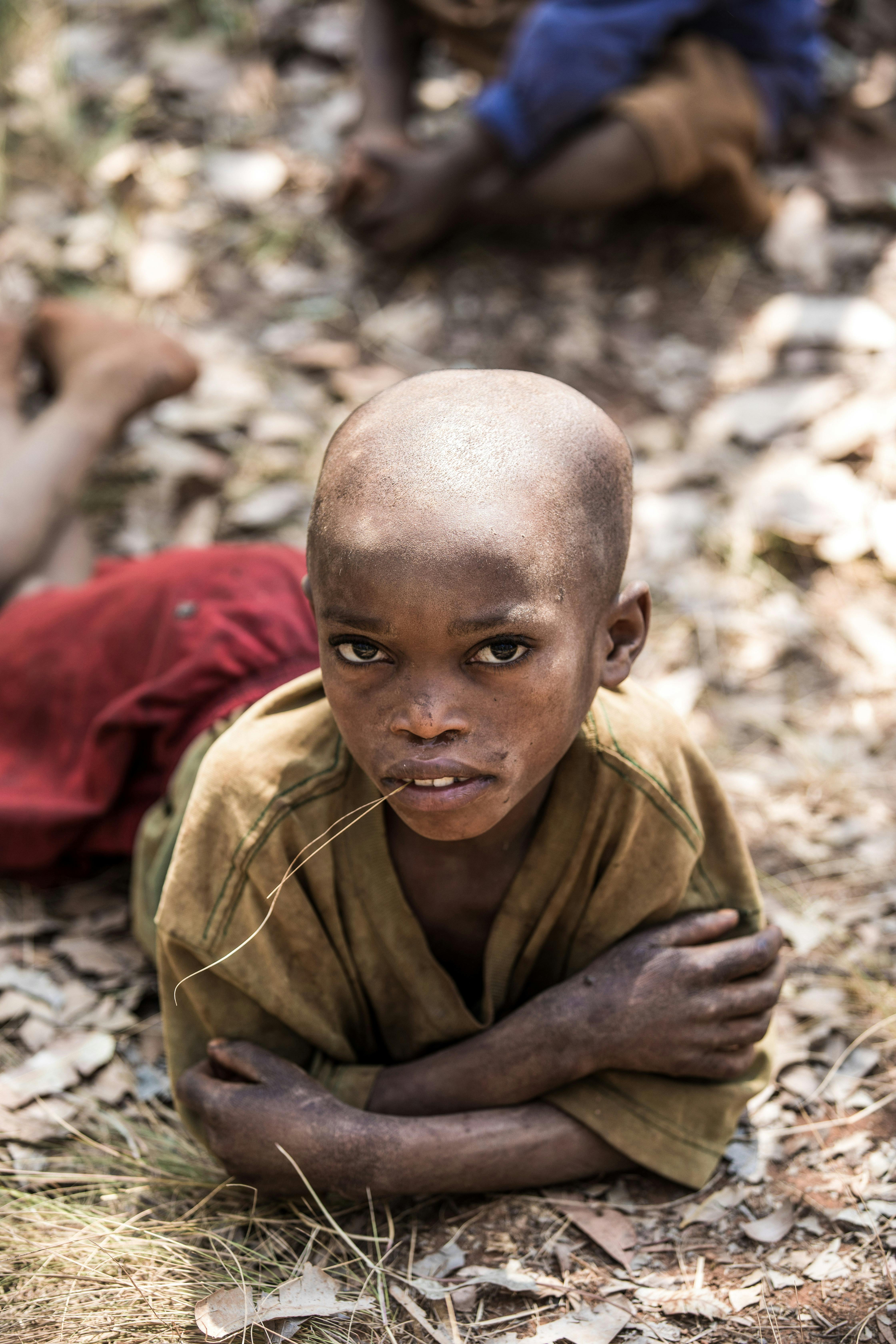 Bald Child Lying on Ground · Free Stock Photo