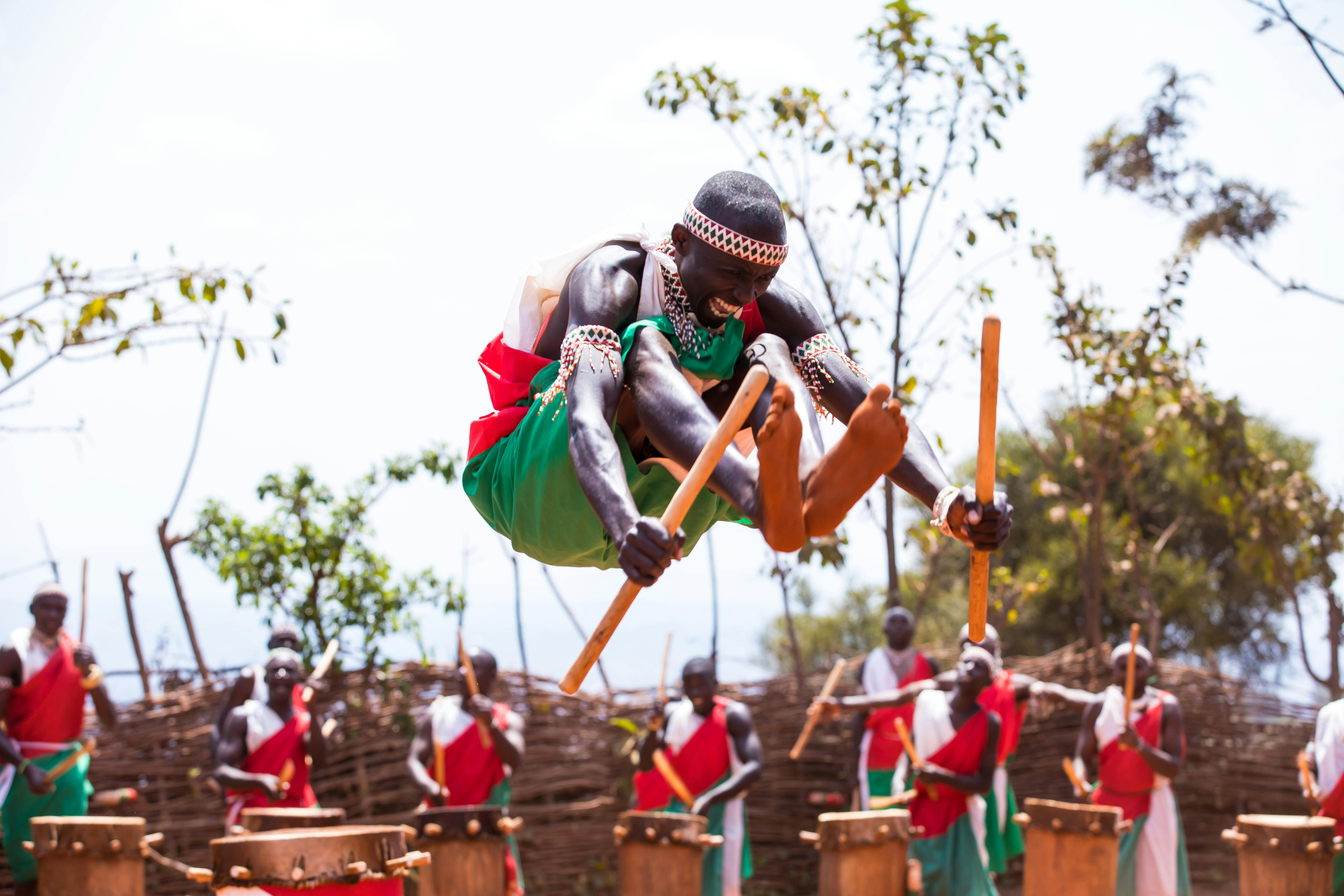 Man in Traditional Clothing Jumping at Festival · Free Stock Photo