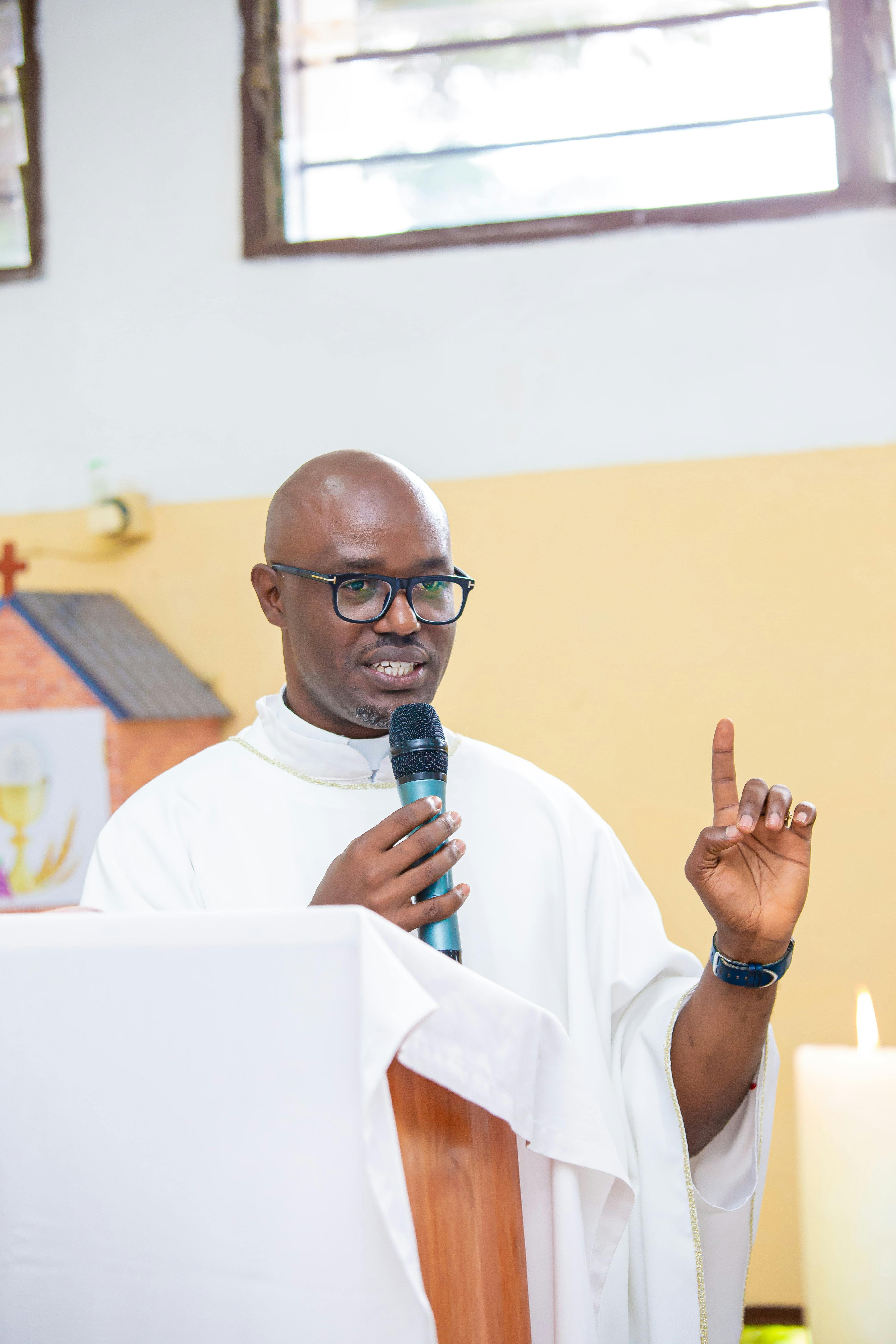A Priest with a Microphone · Free Stock Photo