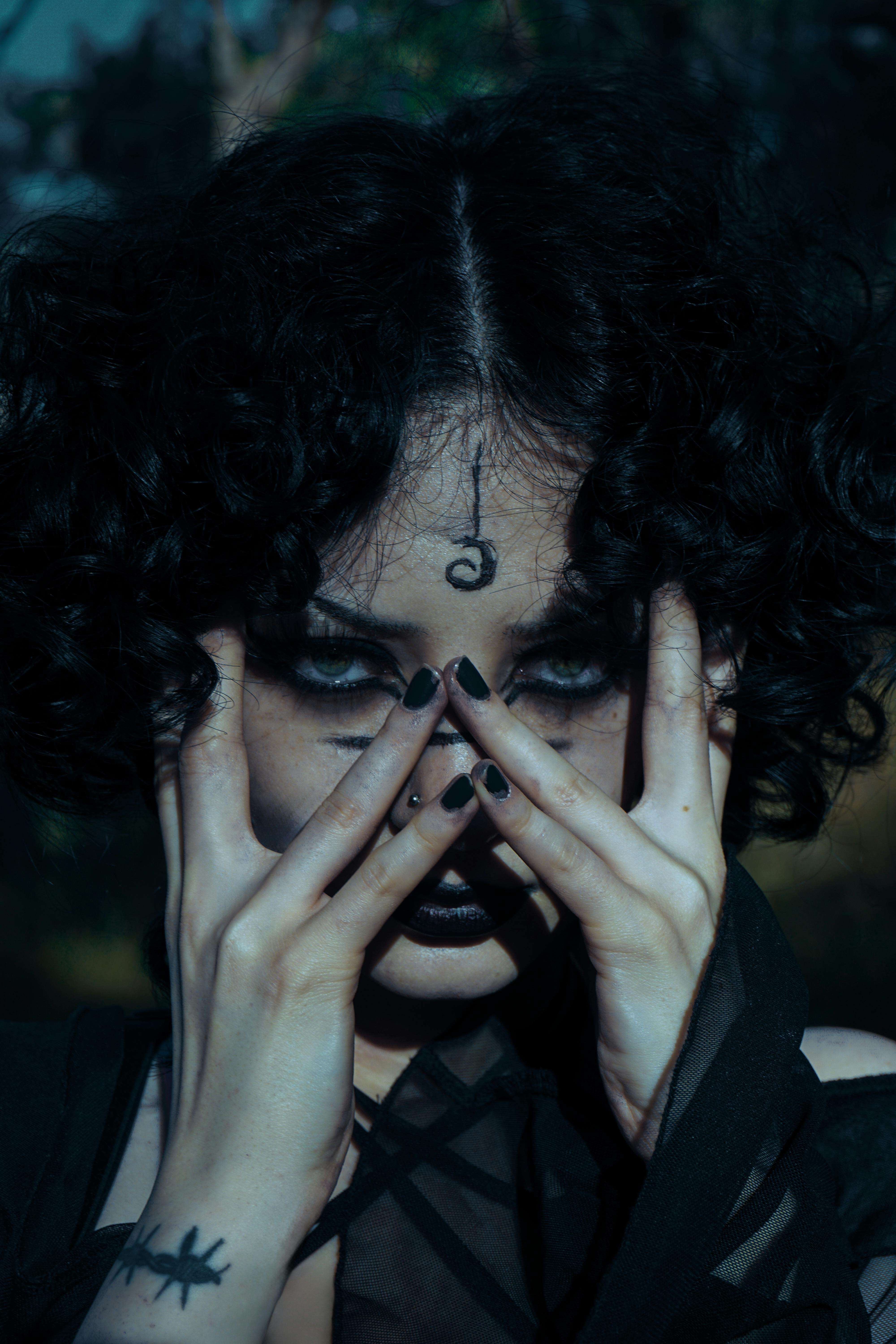 Portrait of a Pretty Brunette Wearing Goth Face Paint · Free Stock Photo