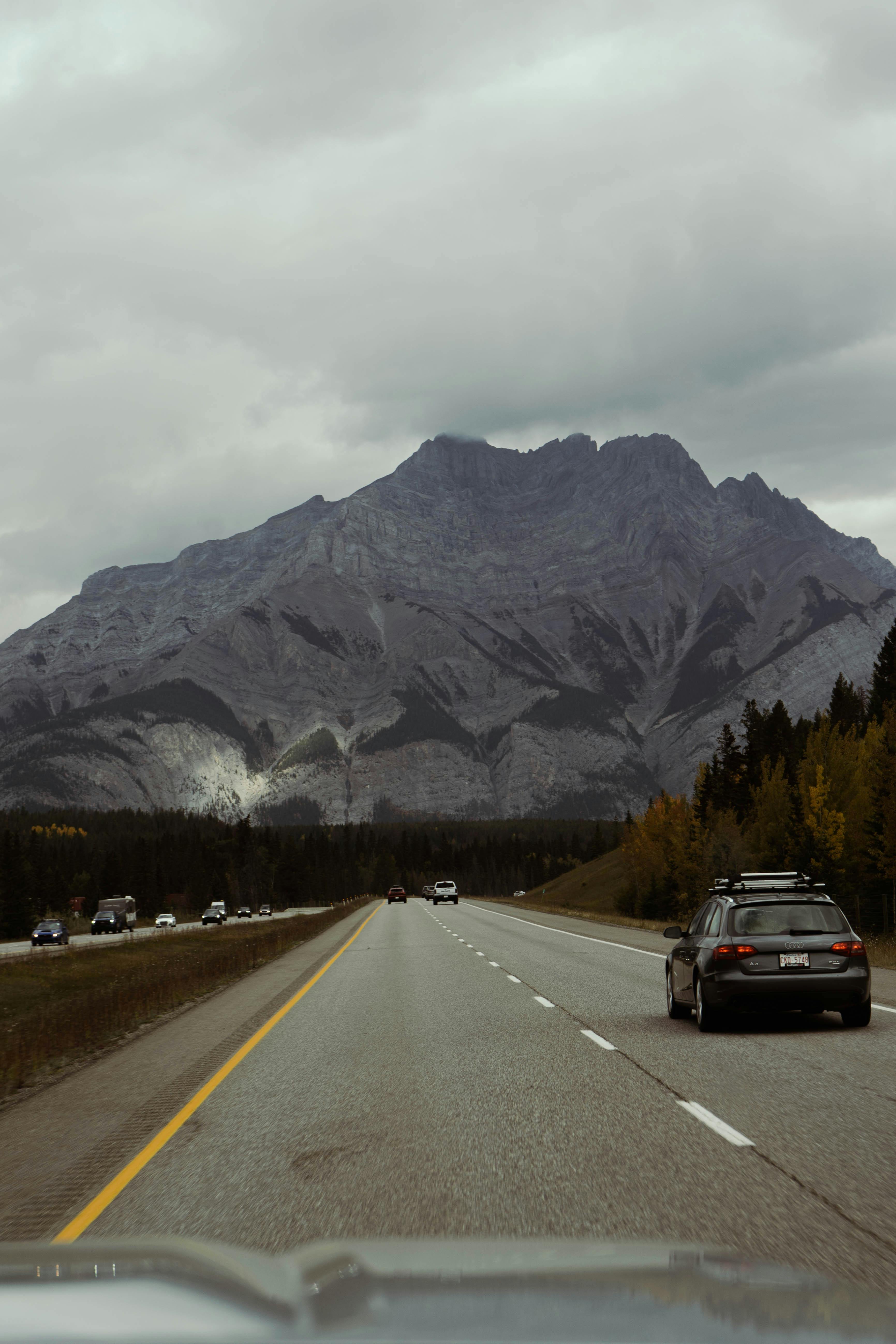 Cars on a Highway Stretching toward a Mountain · Free Stock Photo