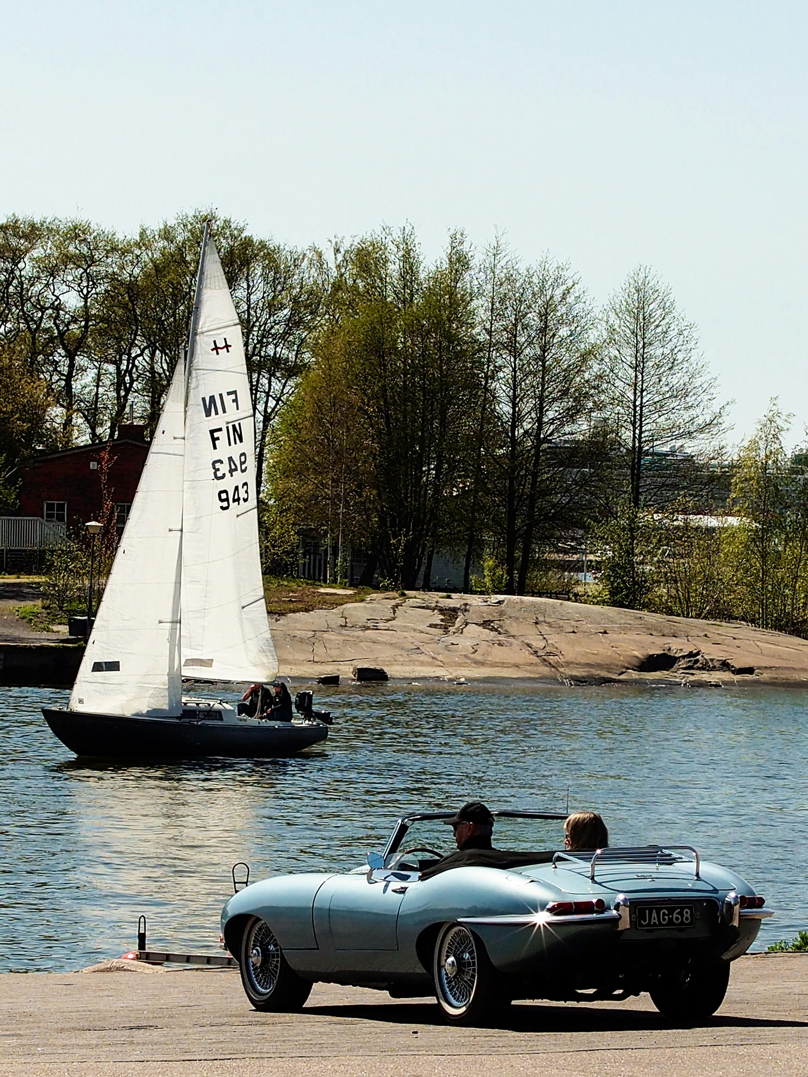 Car by the Lake with Sailboat in It · Free Stock Photo
