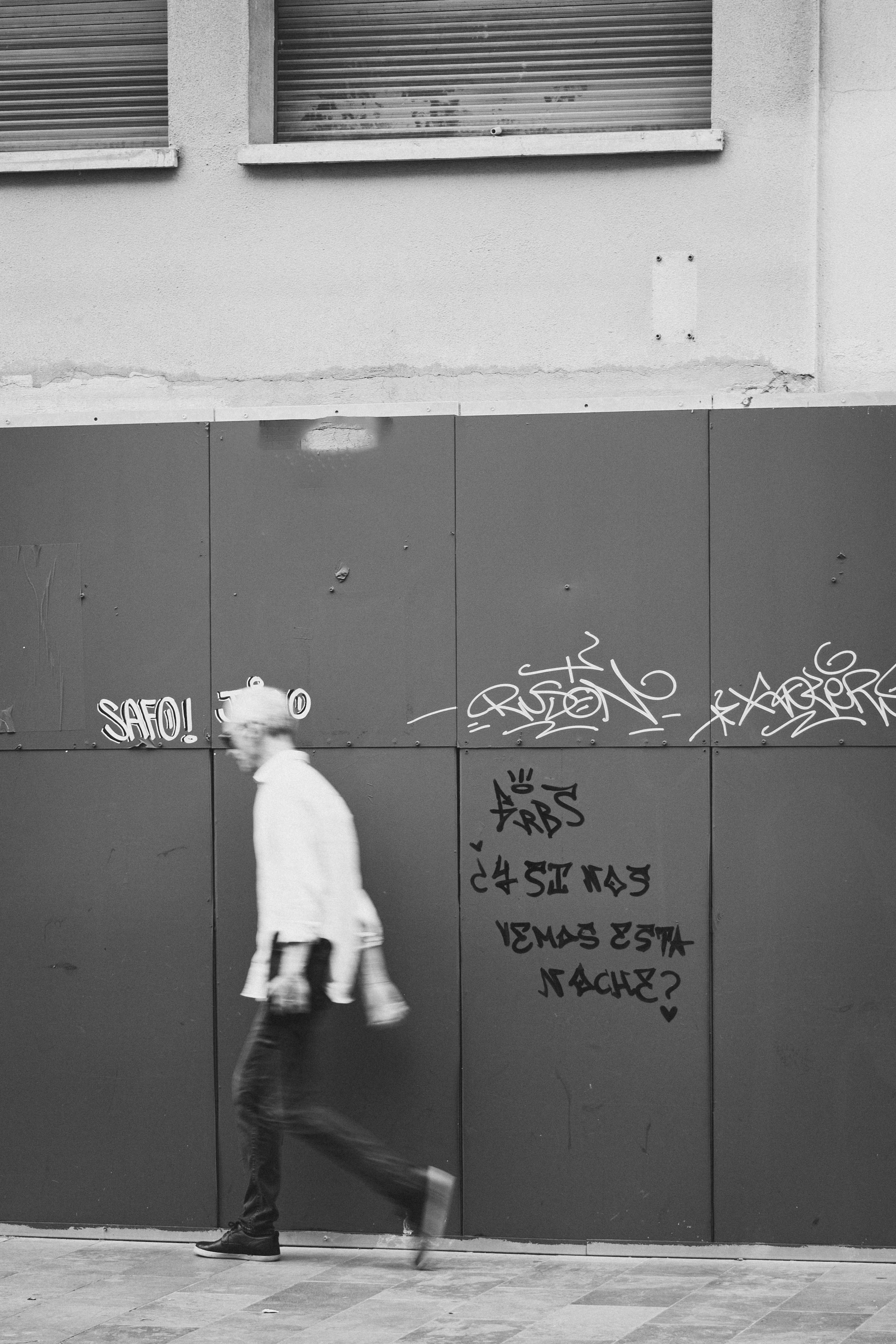 Pedestrian in Hurry Walking Along Wall in City · Free Stock Photo