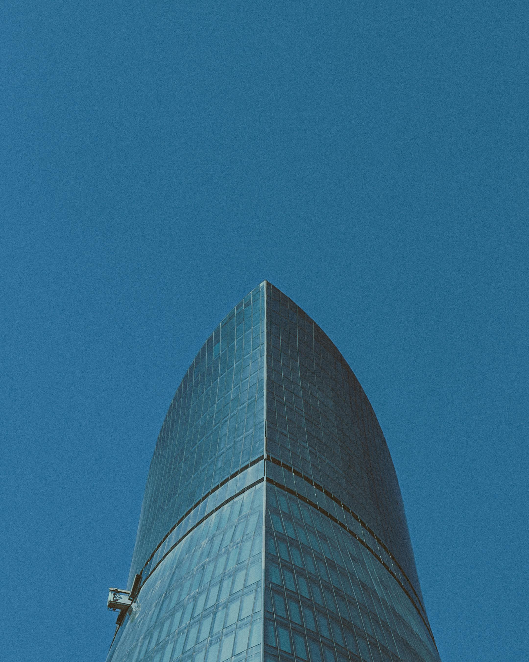 Corner of a Skyscraper Standing against a Clear Sky · Free Stock Photo
