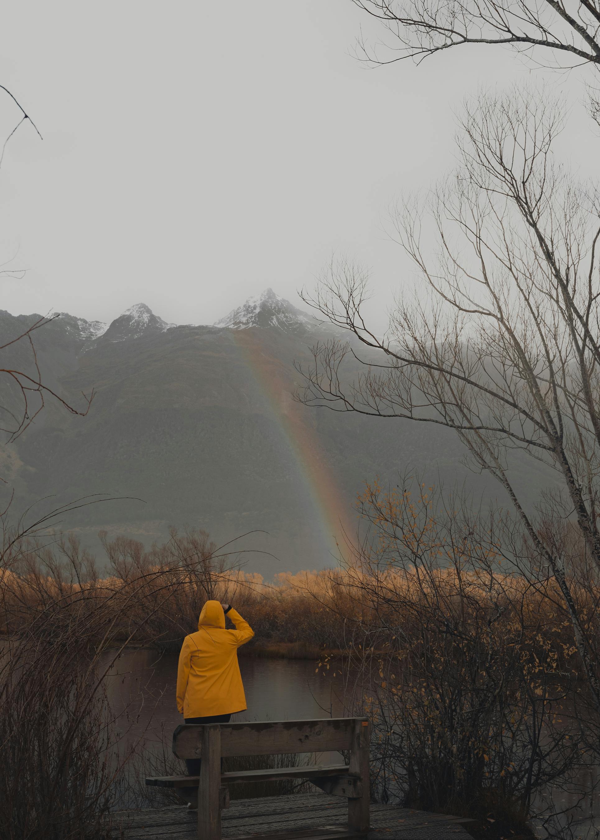 Tourist in a Yellow Raincoat Watching Rainbow on Lake Wakatipu · Free ...