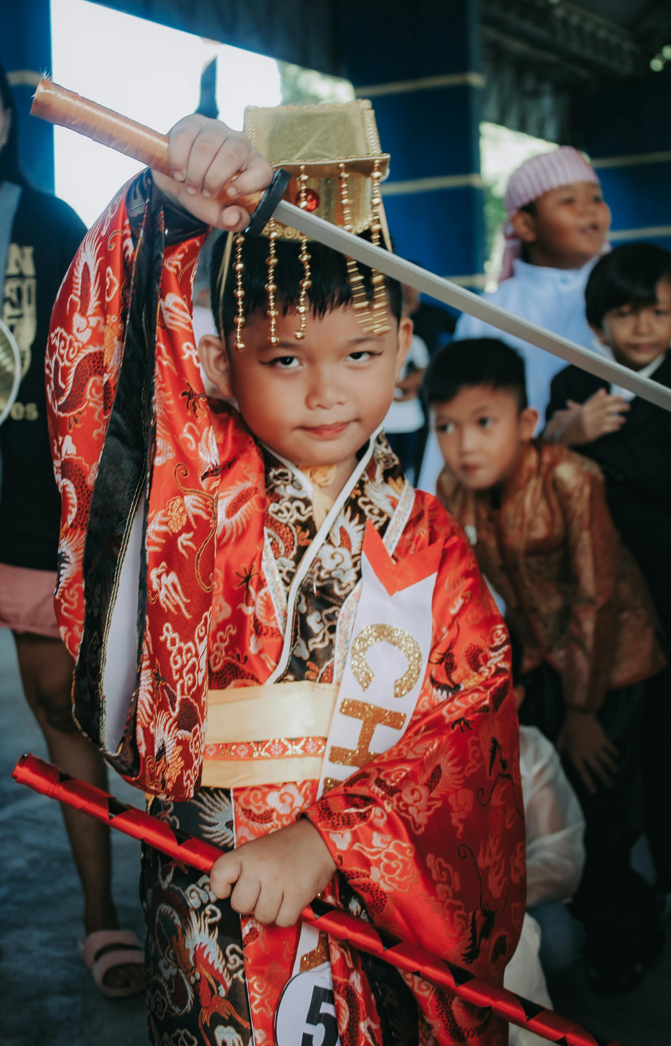 Boy in Traditional Japanese Clothing Holding Swords · Free Stock Photo