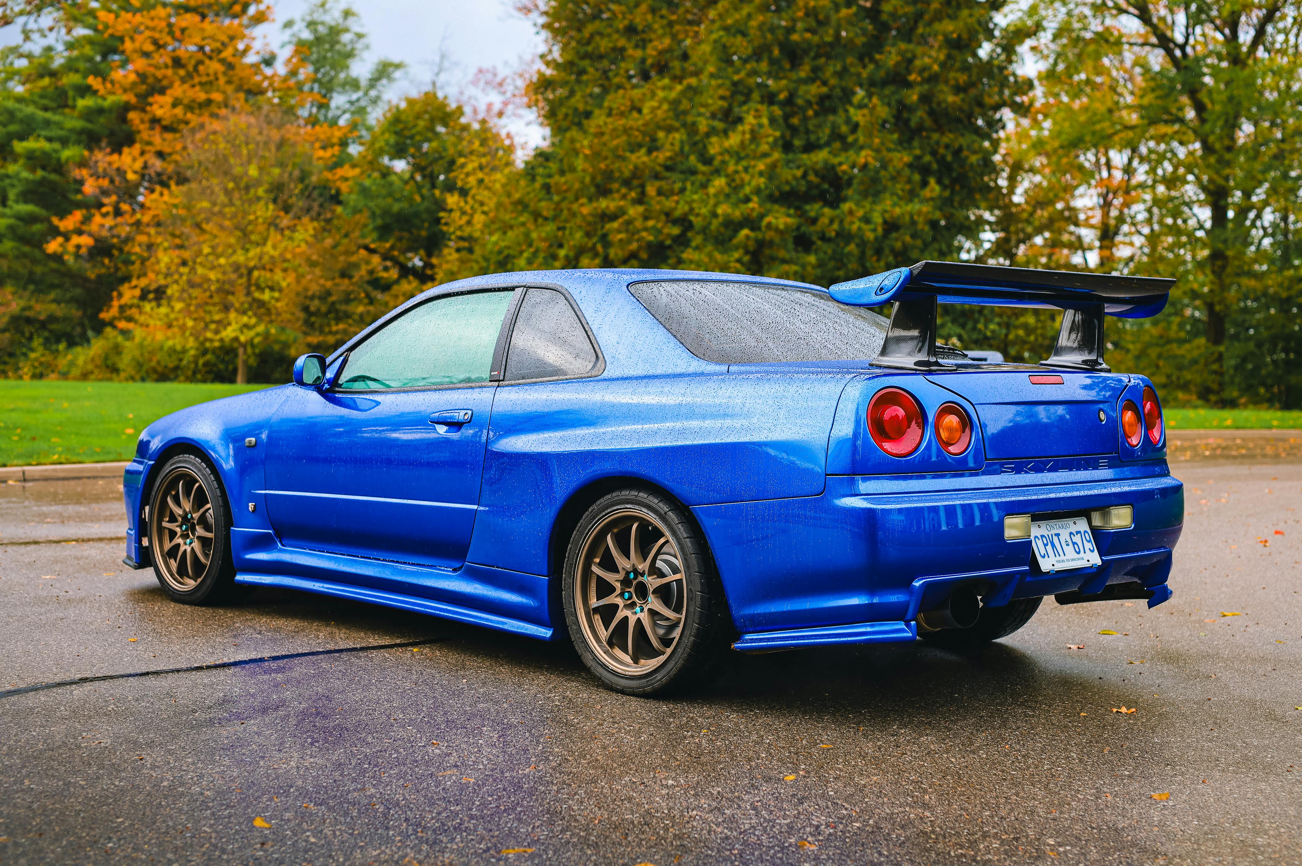 A blue nissan gtr parked on the side of the road · Free Stock Photo