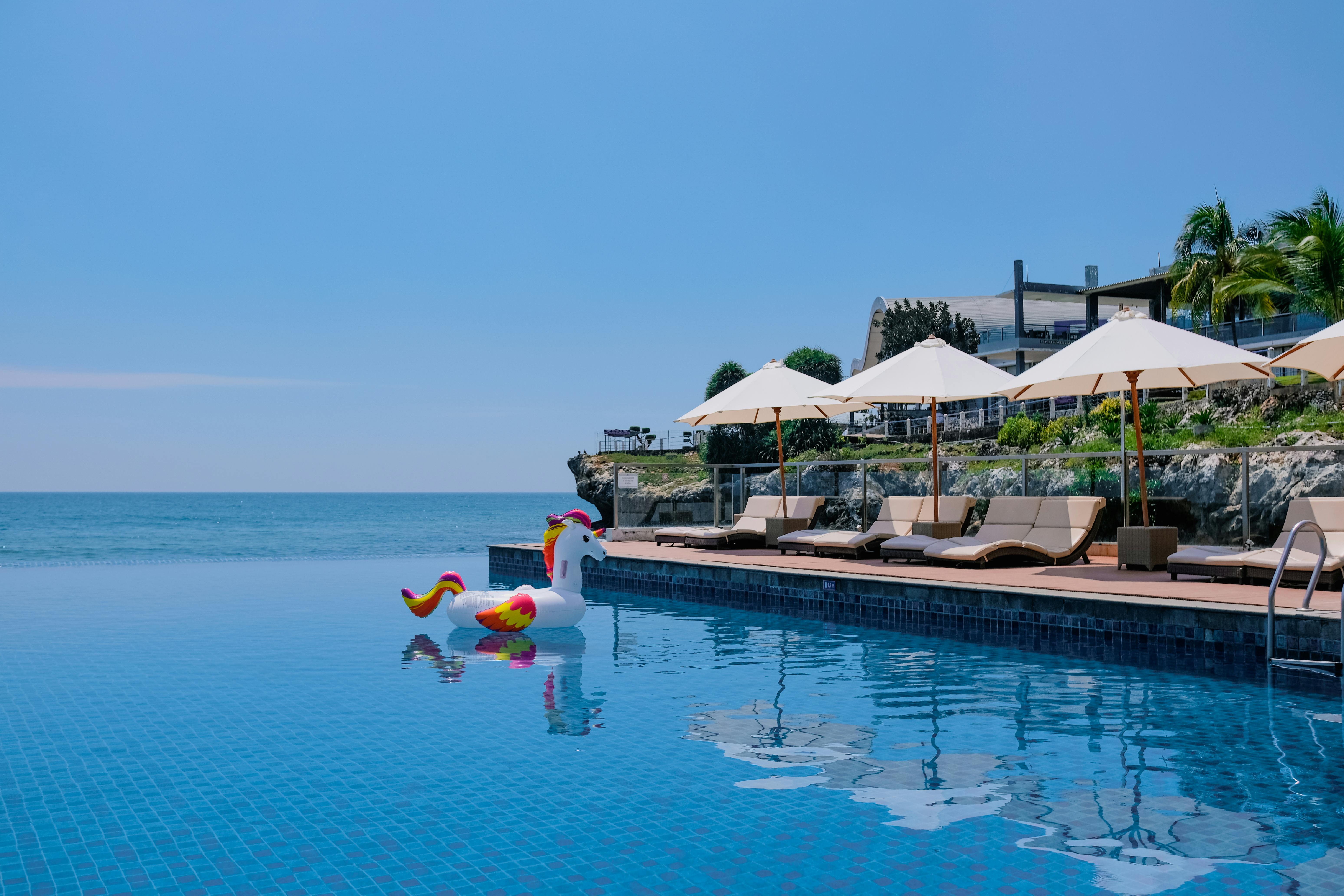 Inflatable Unicorn Float in the Infinity Pool of a Seaside Resort ...