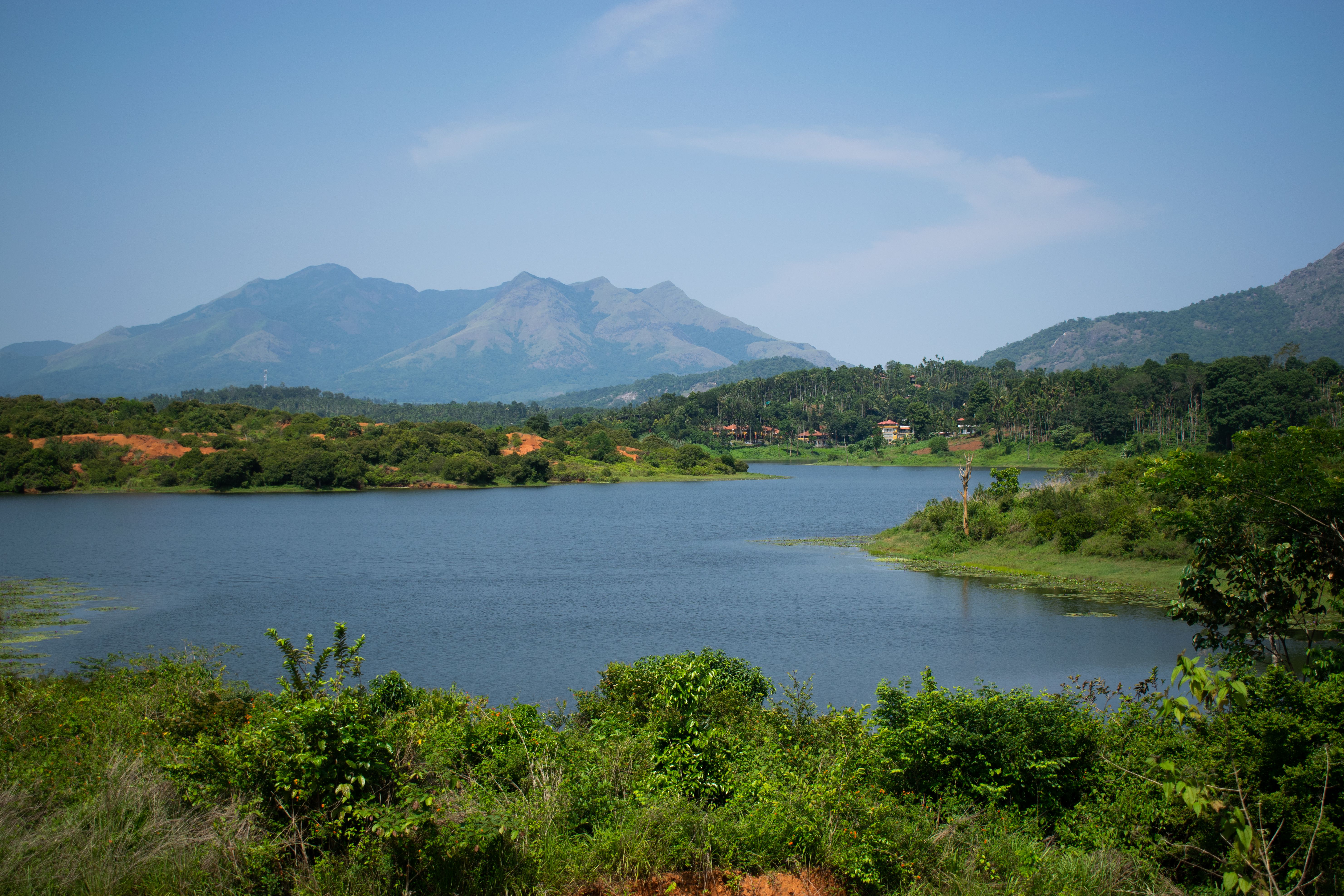 Scenic Shot of a Lake and Distant Hills and Mountains · Free Stock Photo