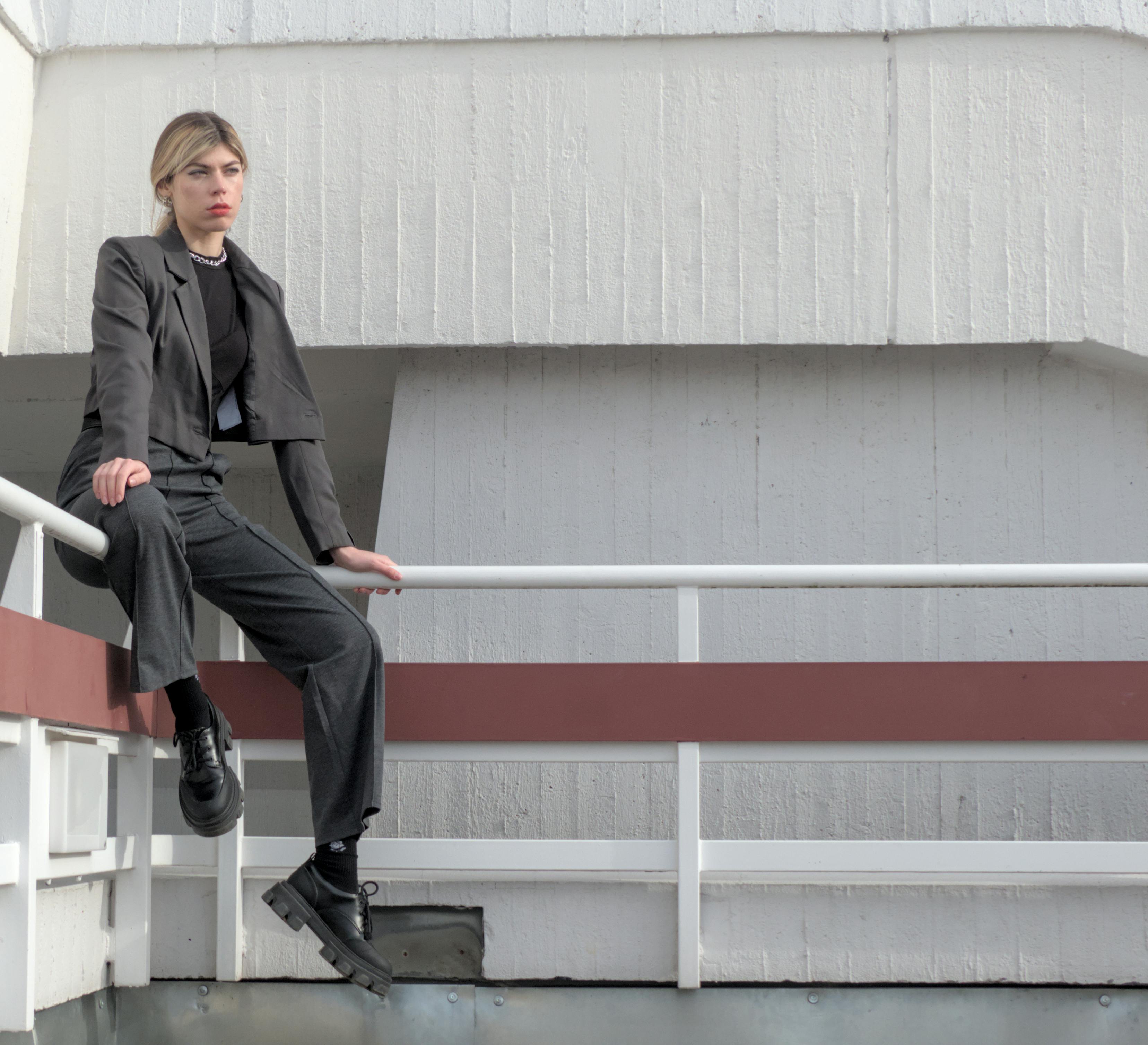 Woman Sitting on the Railing · Free Stock Photo