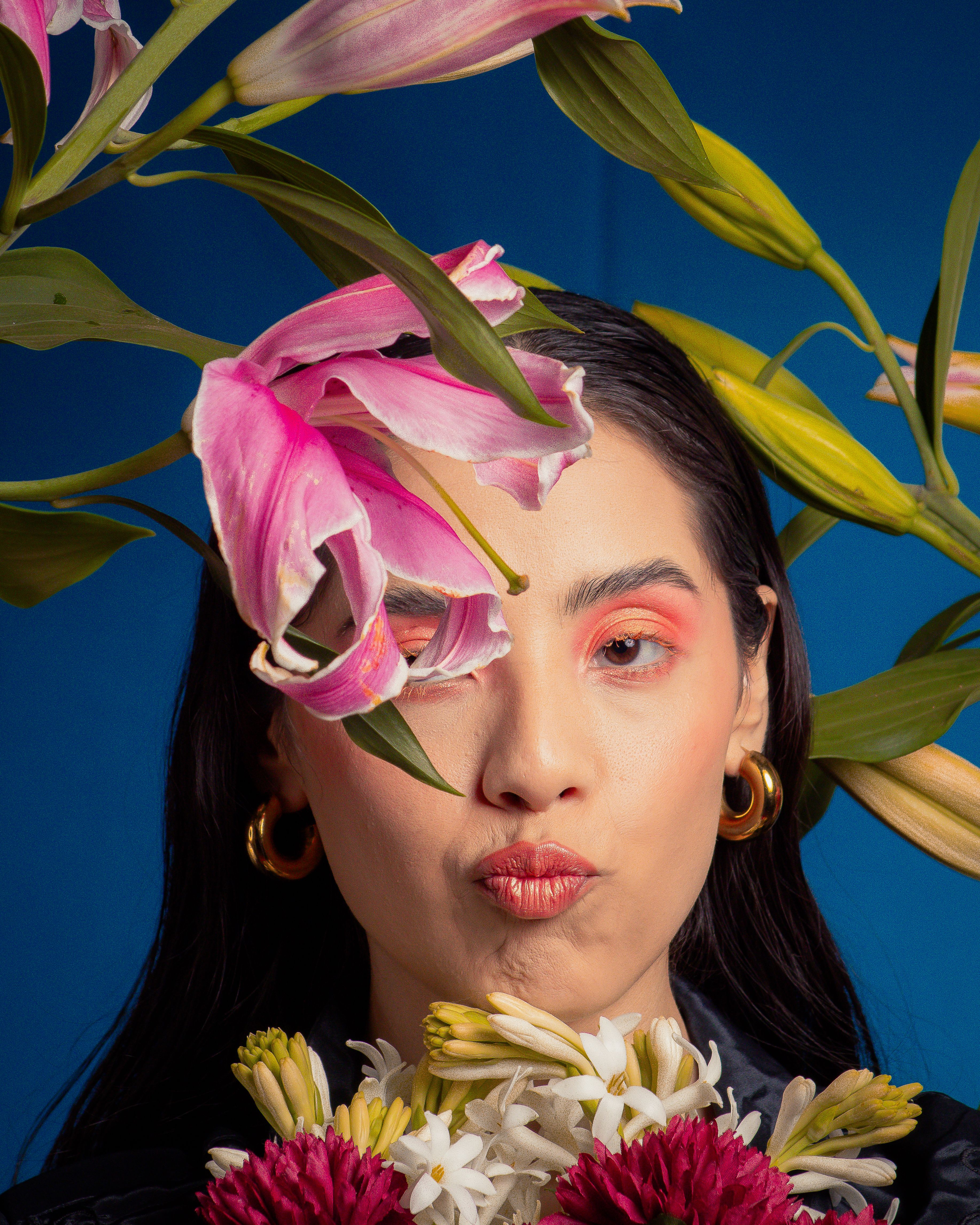 A woman with flowers in her hair and a flower on her nose · Free Stock ...