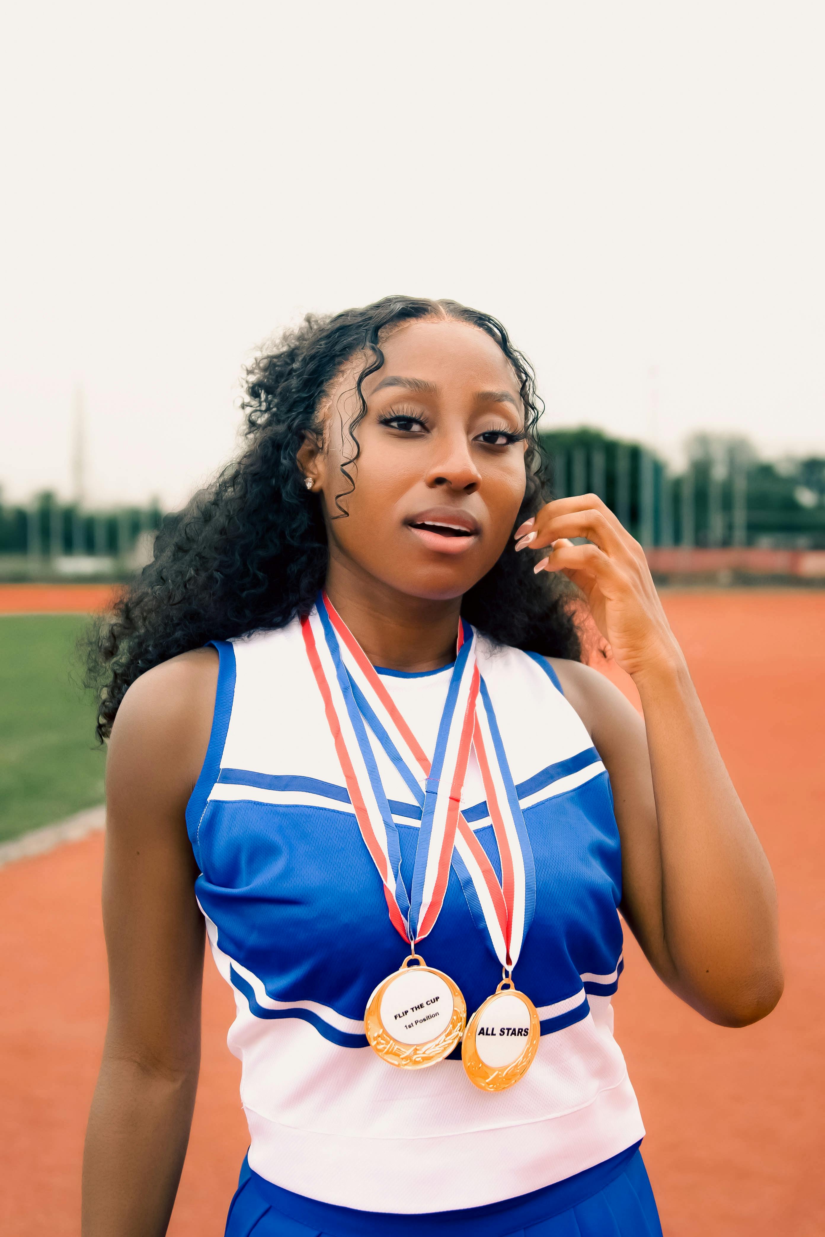 Sportswoman with Medals on a Running Track · Free Stock Photo
