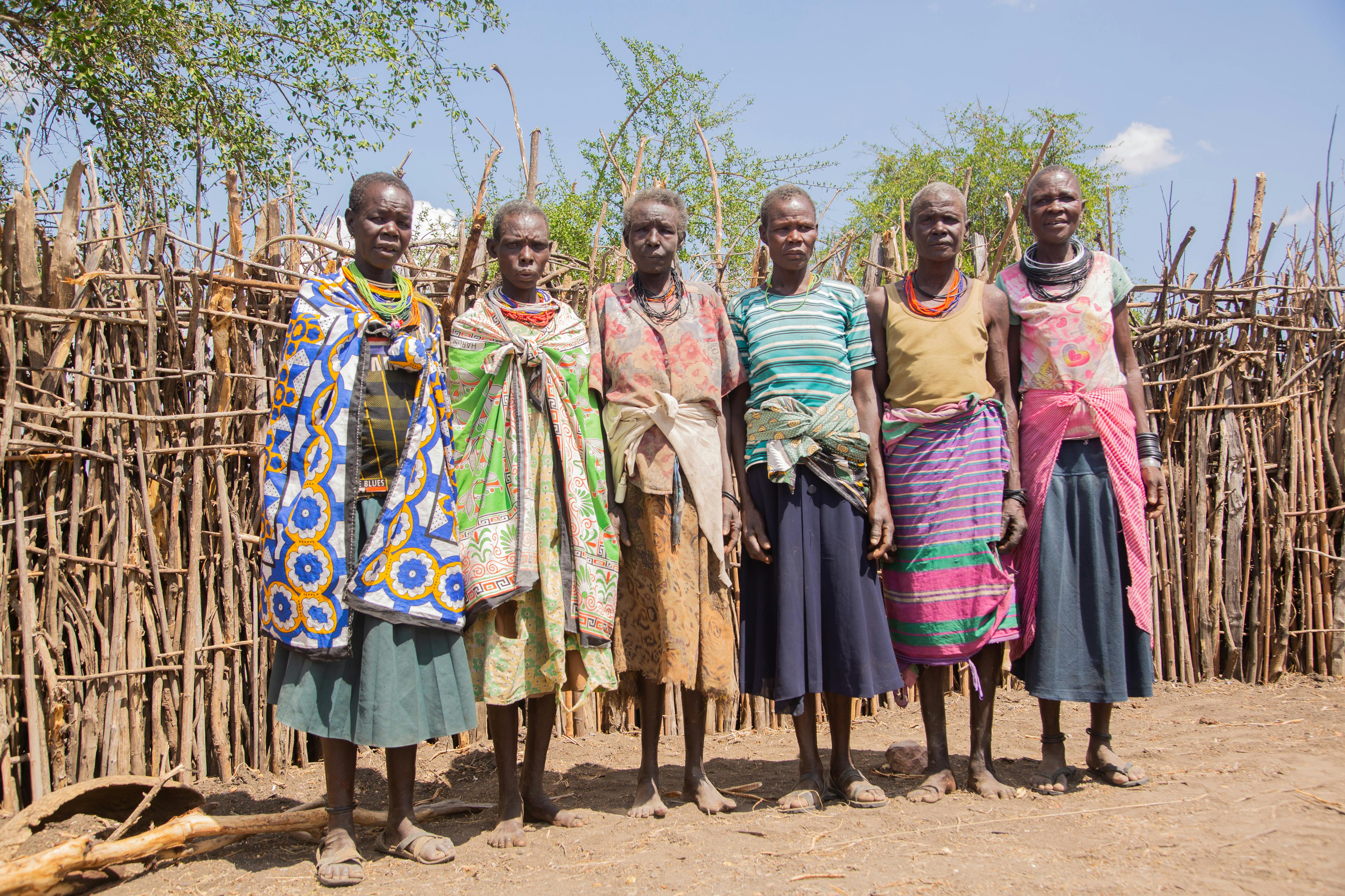 Group of People From an African Village by a Stick Fence · Free Stock Photo